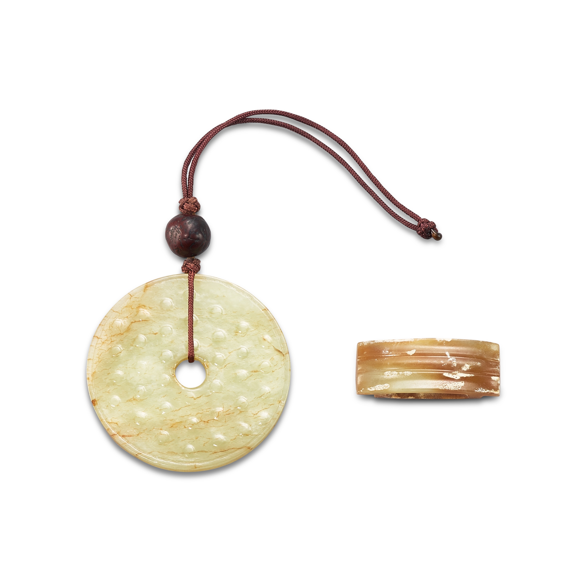 A jade scabbard slide, Late Warring States period and a white jade bi ...