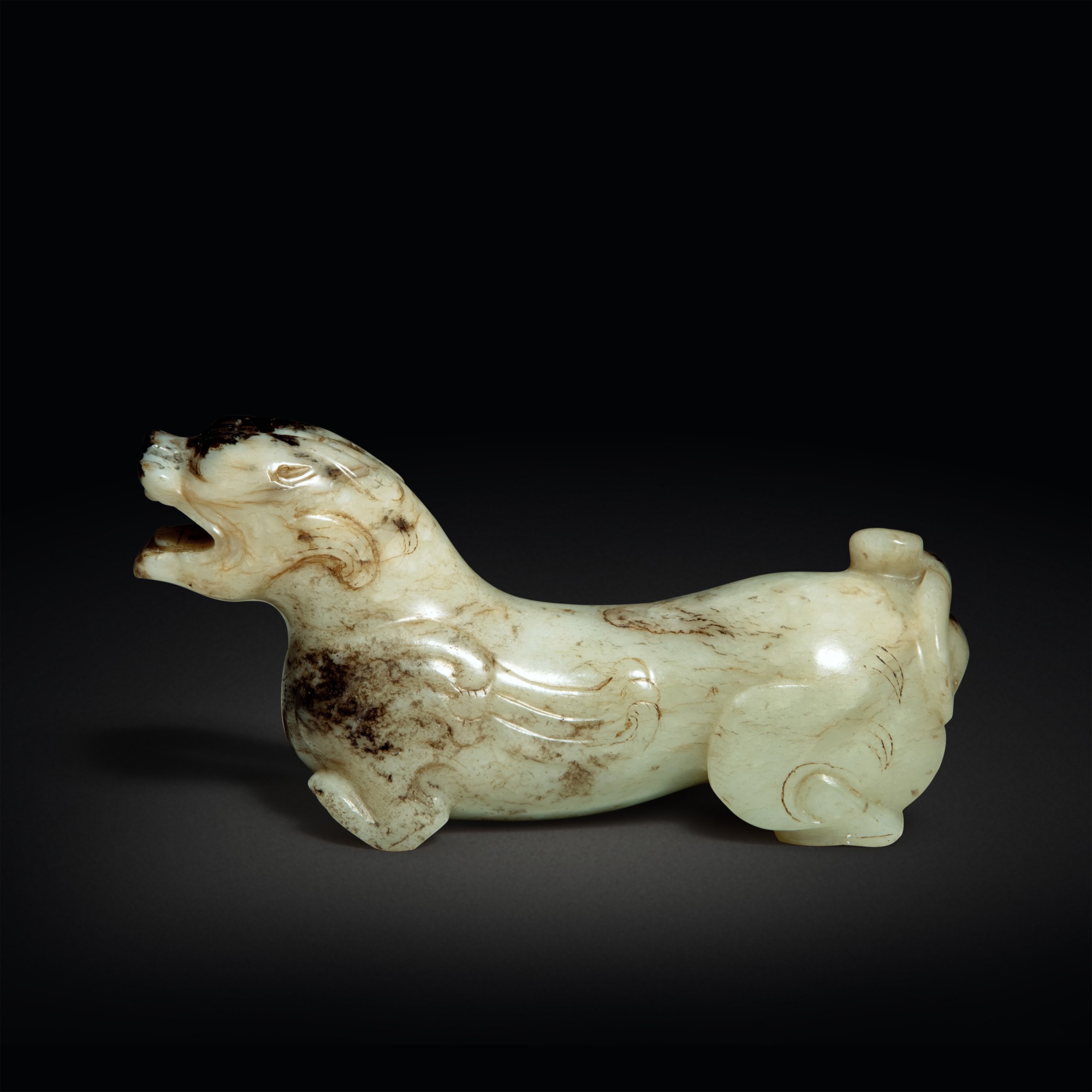 A beige and brown jade figure of a bixie, Ming dynasty or later | 明或以後 ...