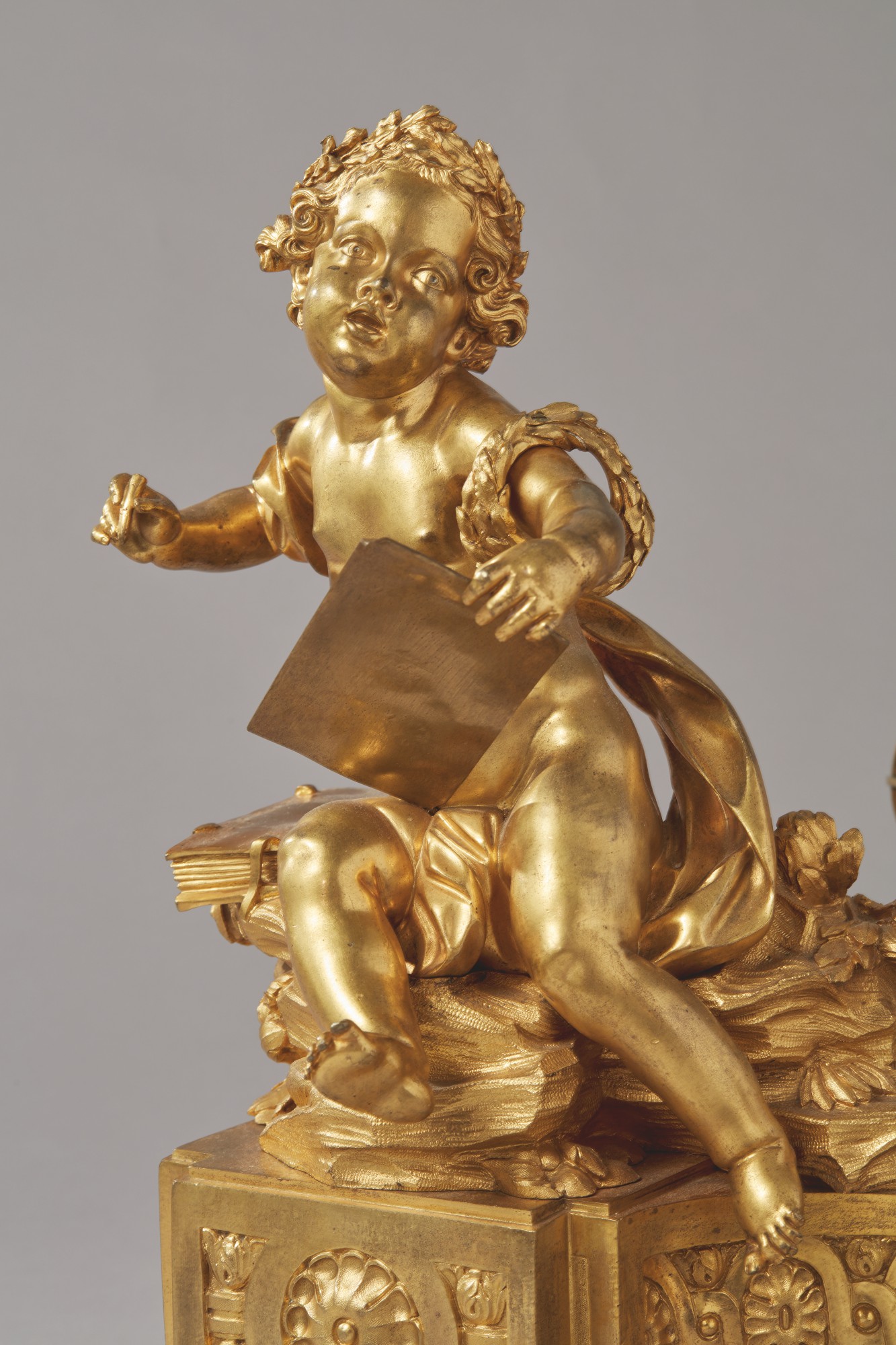 A PAIR OF LOUIS XVI GILT-BRONZE CHENETS REPRESENTING LITERATURE AND ...
