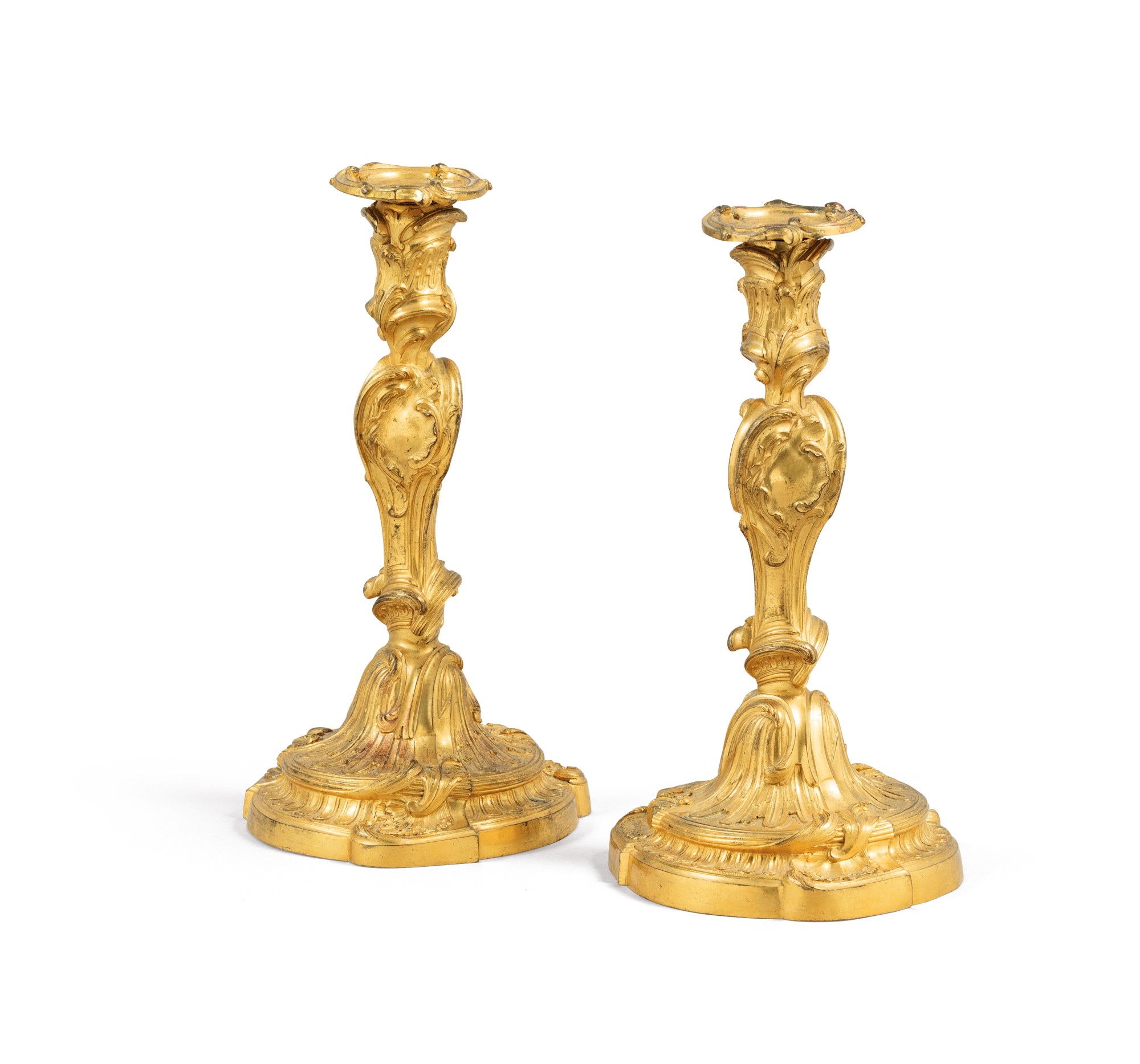 A pair of Louis XV gilt-bronze candlesticks, in the manner of Jules ...