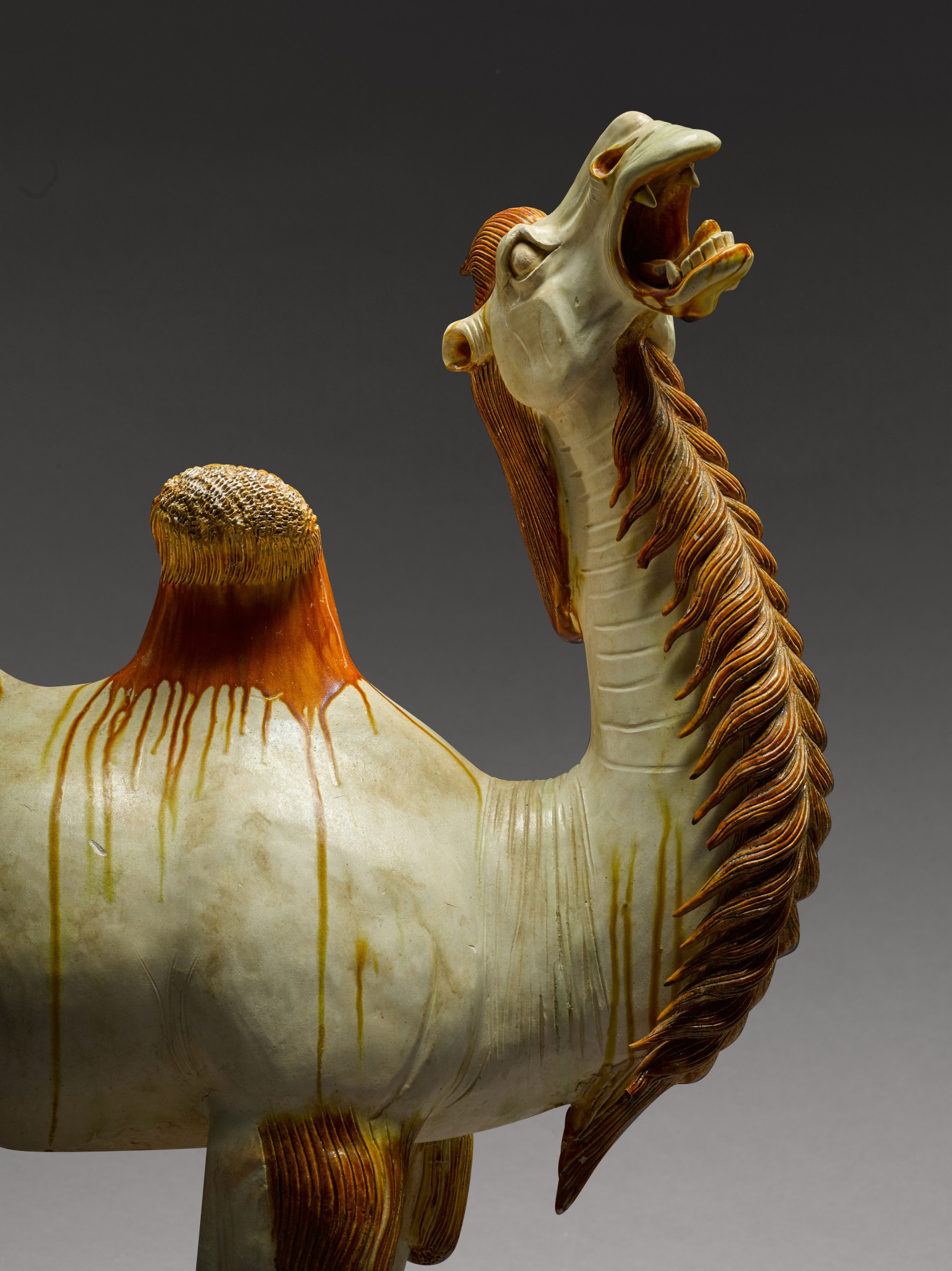 A magnificent amber and straw-glazed pottery figure of a Bactrian camel ...