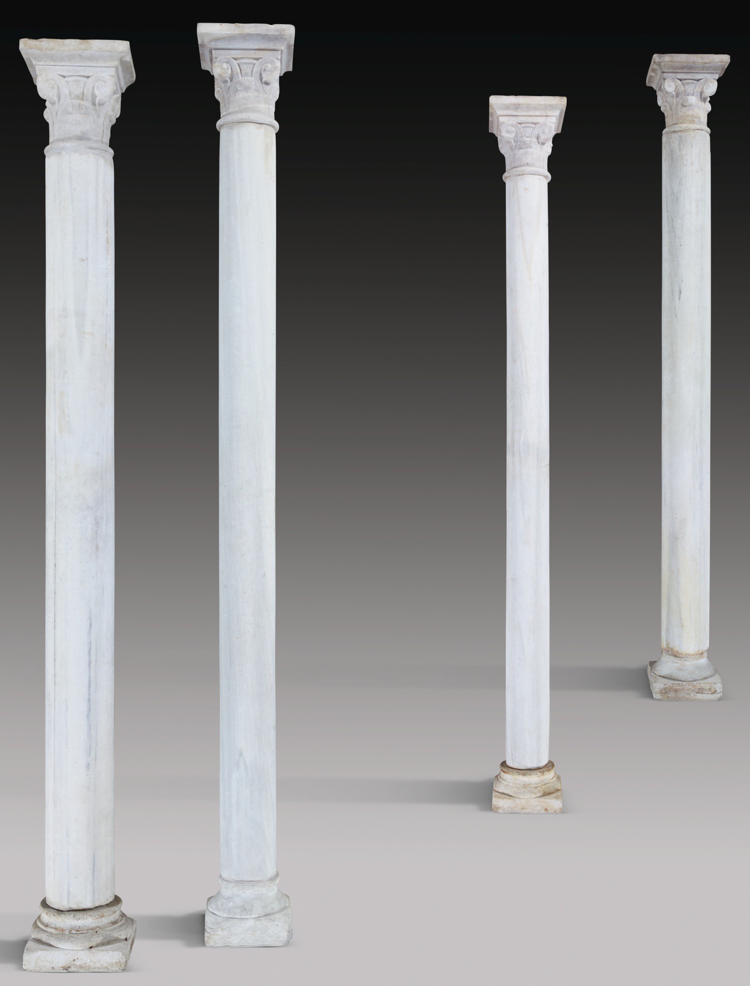 FOUR MONUMENTAL NASRID CARVED MARBLE COLUMNS AND CAPITALS, ANDALUSIA ...