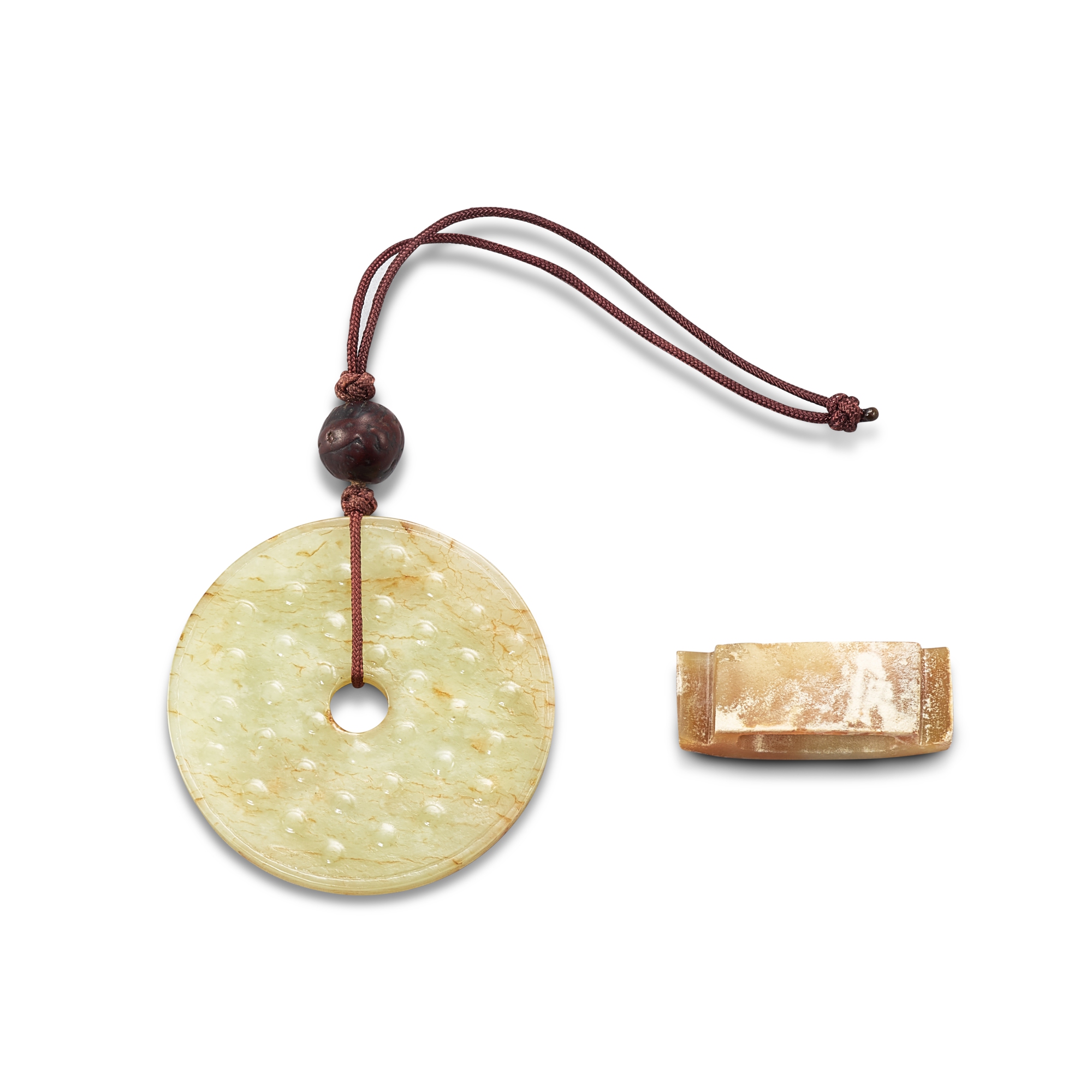 A jade scabbard slide, Late Warring States period and a white jade bi ...