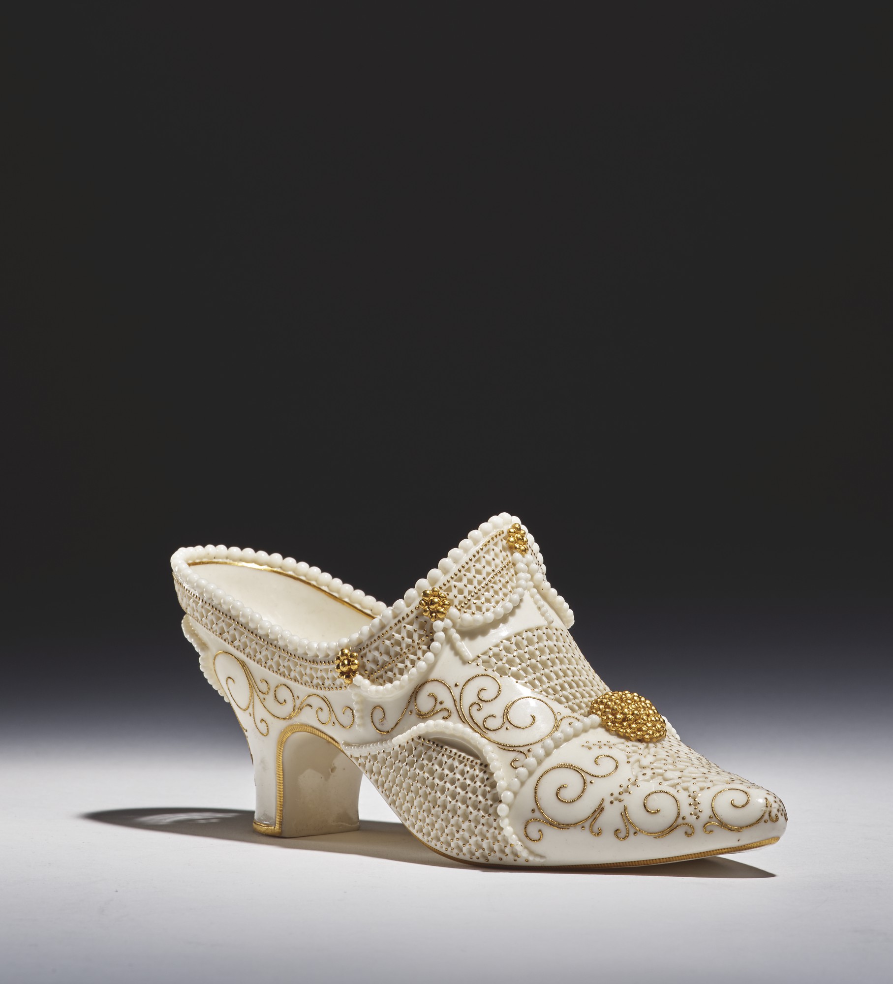 A ROYAL WORCESTER RETICULATED PORCELAIN MODEL OF A SHOE BY GEORGE OWEN ...