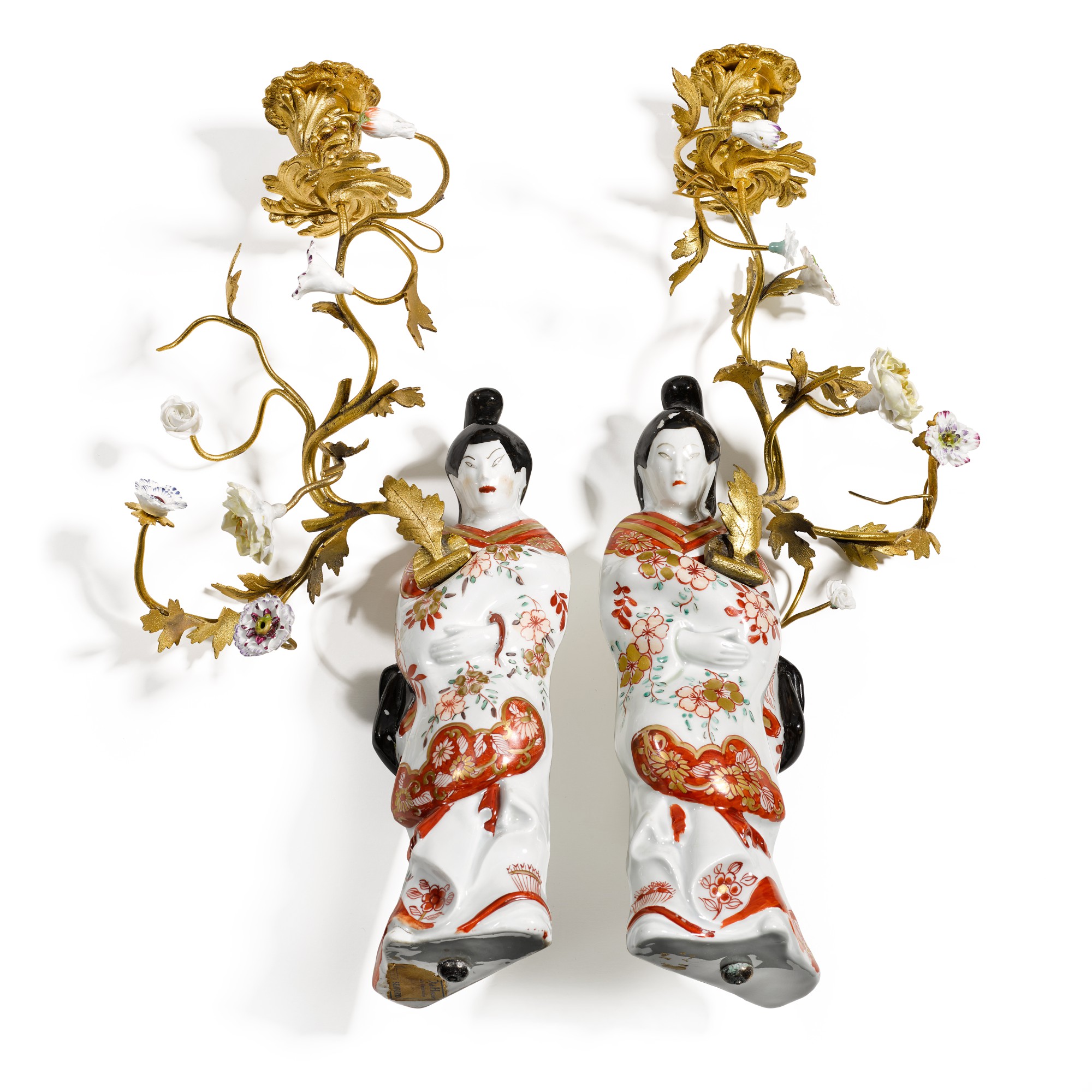 A pair of Japanese porcelain figural wall flower holders, with later ...