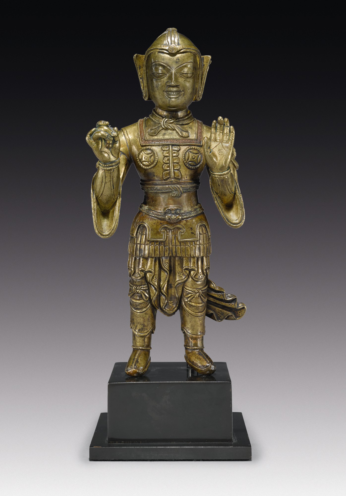 A COPPER ALLOY FIGURE OF A GUARDIAN WITH COPPER INLAY, TIBET, 13TH ...