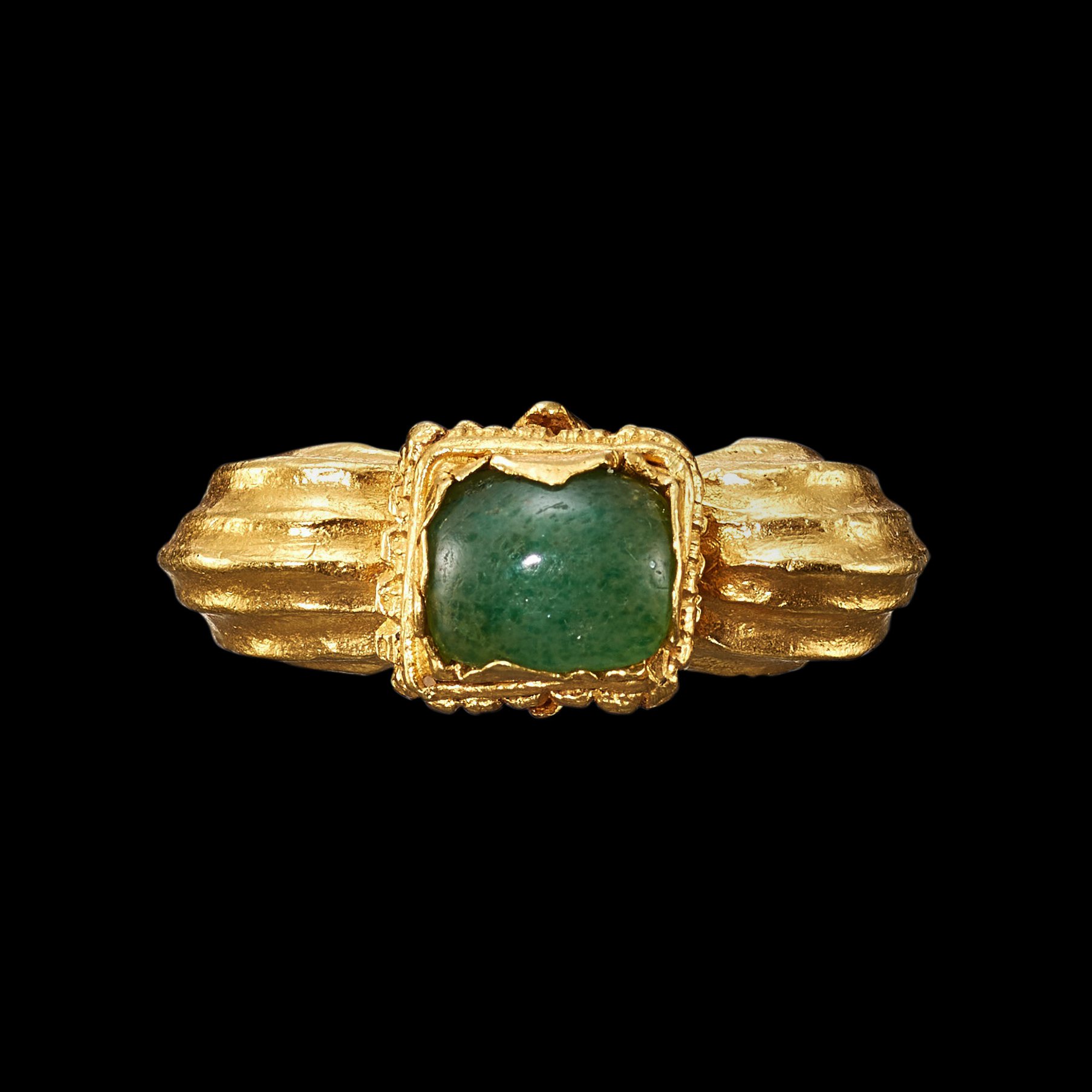A solid gold and serpentine ring with ribbed shoulders Java, Indonesia ...