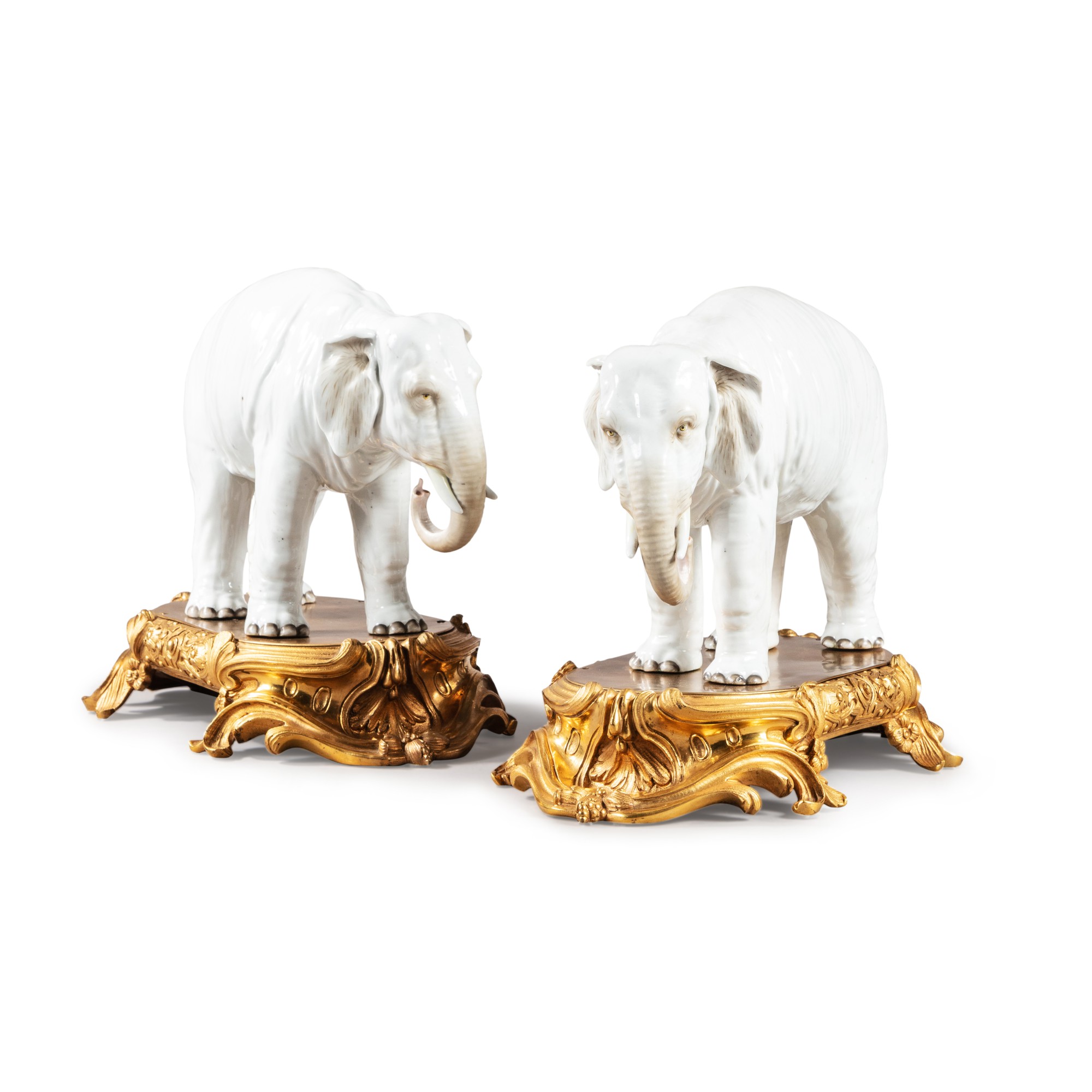 A pair of gilt-bronze mounted porcelain models of elephants, the ...