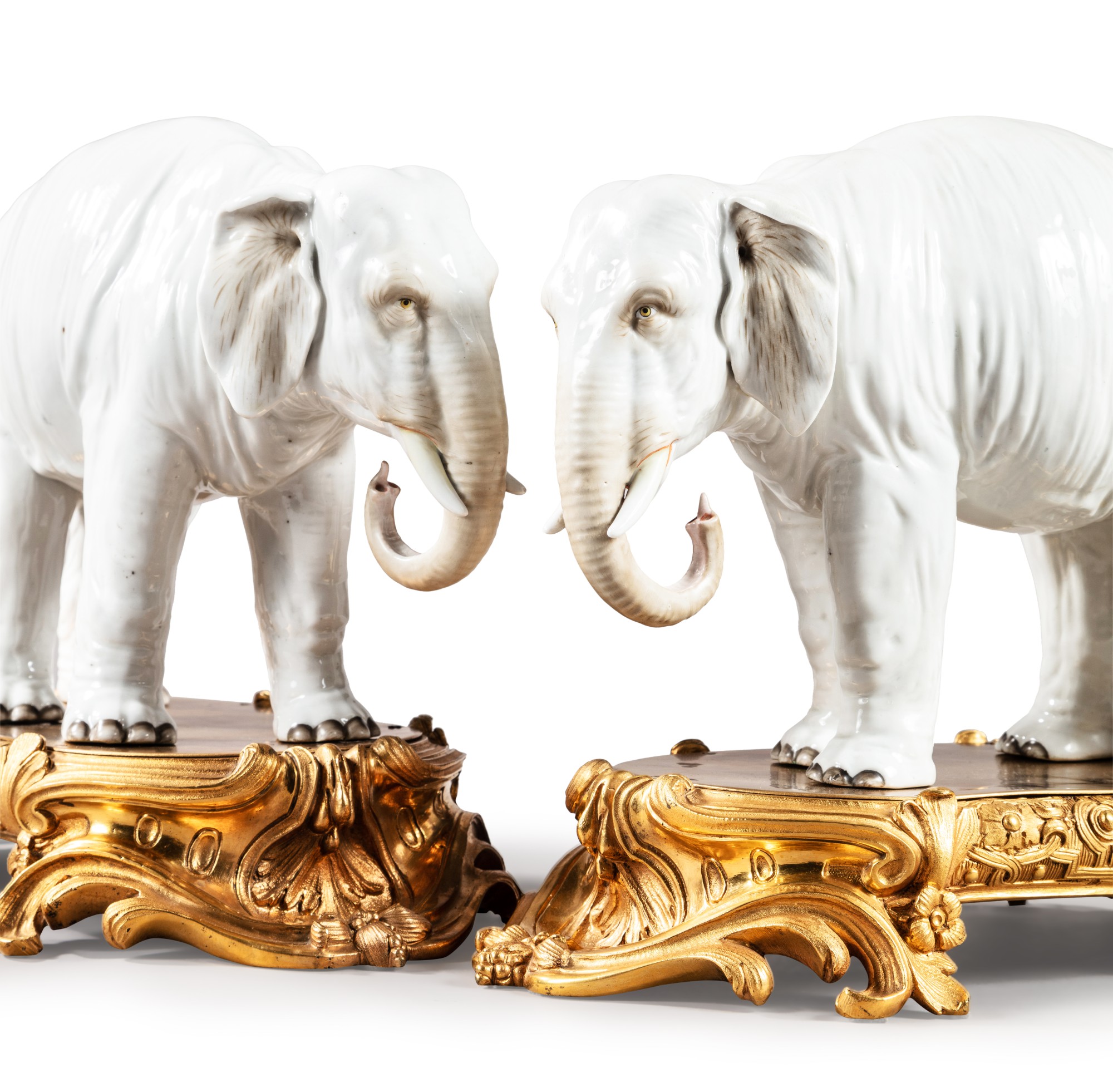 A pair of gilt-bronze mounted porcelain models of elephants, the ...