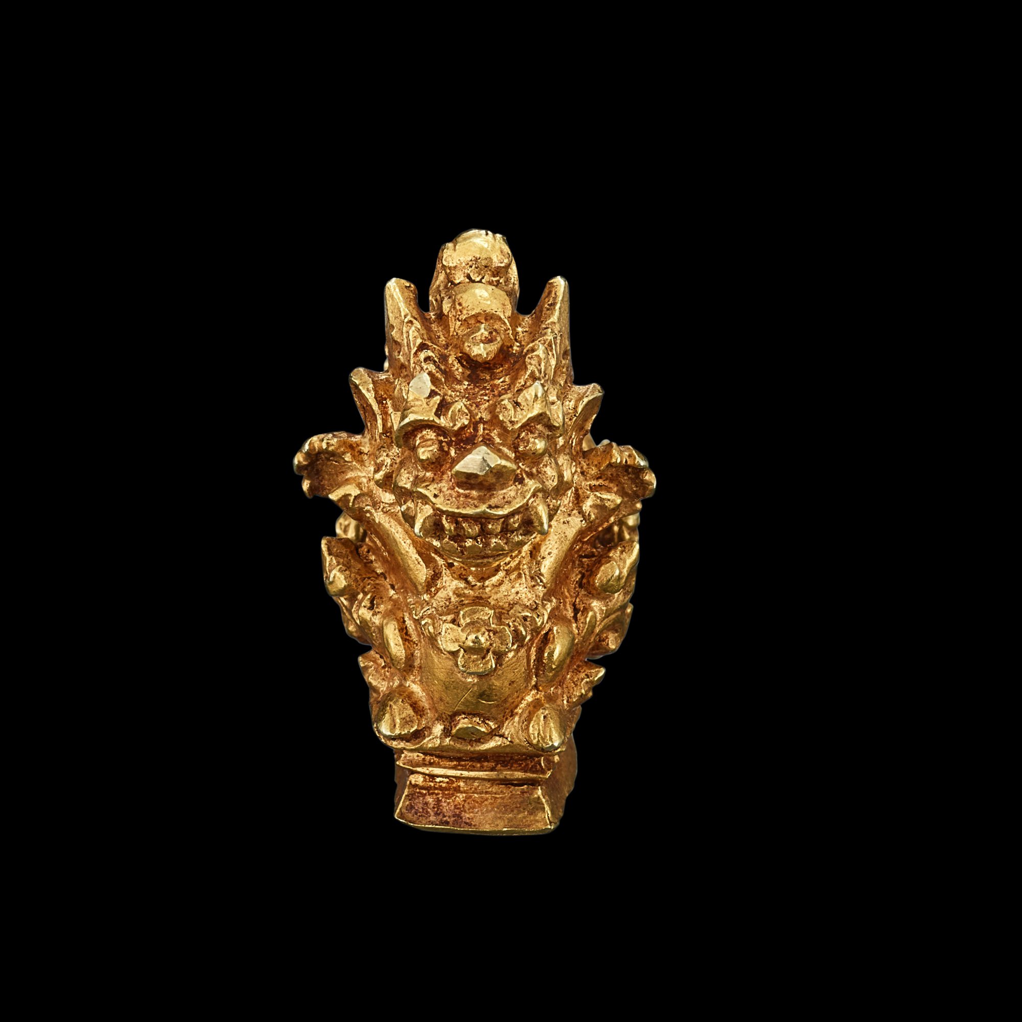 A solid gold earring with seated Singa Java, Indonesia, 7th - 12th ...