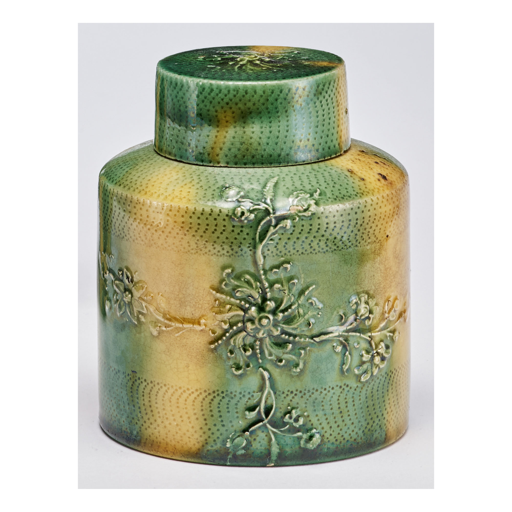 A LEAD-GLAZED CREAM-COLORED EARTHENWARE CYLINDRICAL TEA CANISTER AND ...