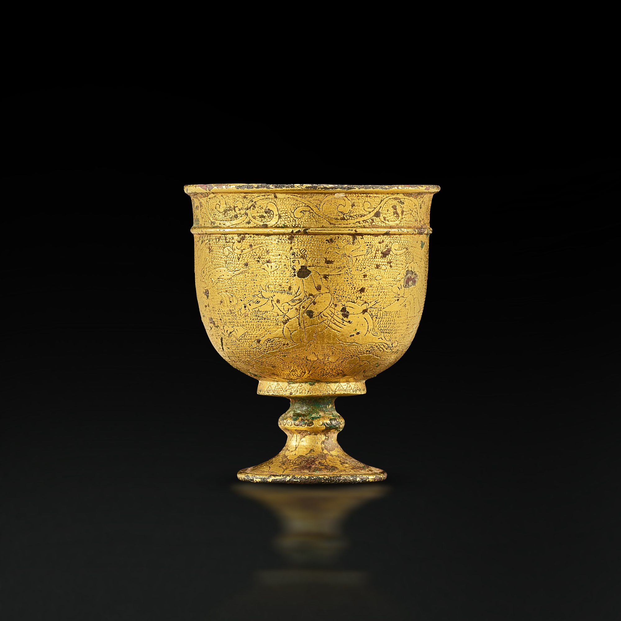 A small finely engraved gilt-bronze 'hunting' stem cup, Tang dynasty ...