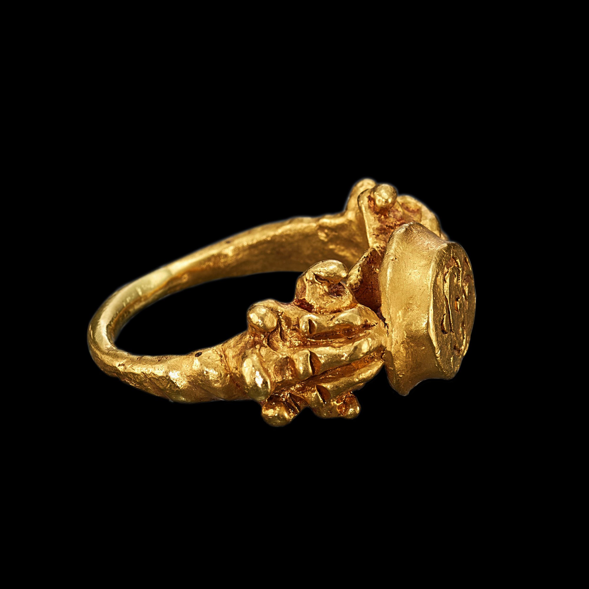 A solid gold ring with an incised bezel of a 'Sri' symbol Java ...