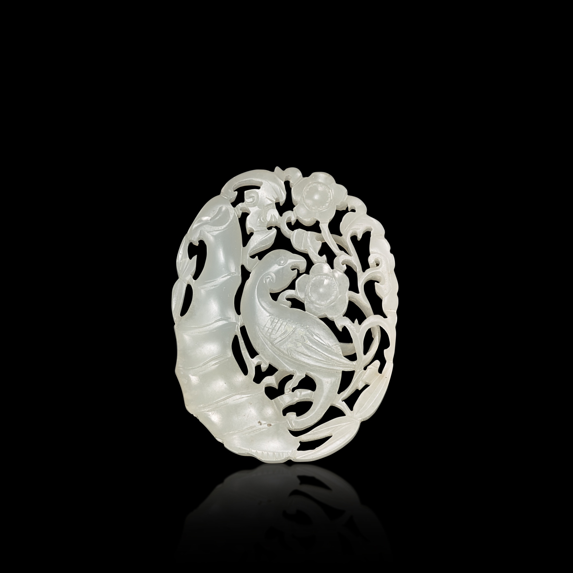 A reticulated white jade 'magpie and prunus' plaque, Qing dynasty, 18th ...