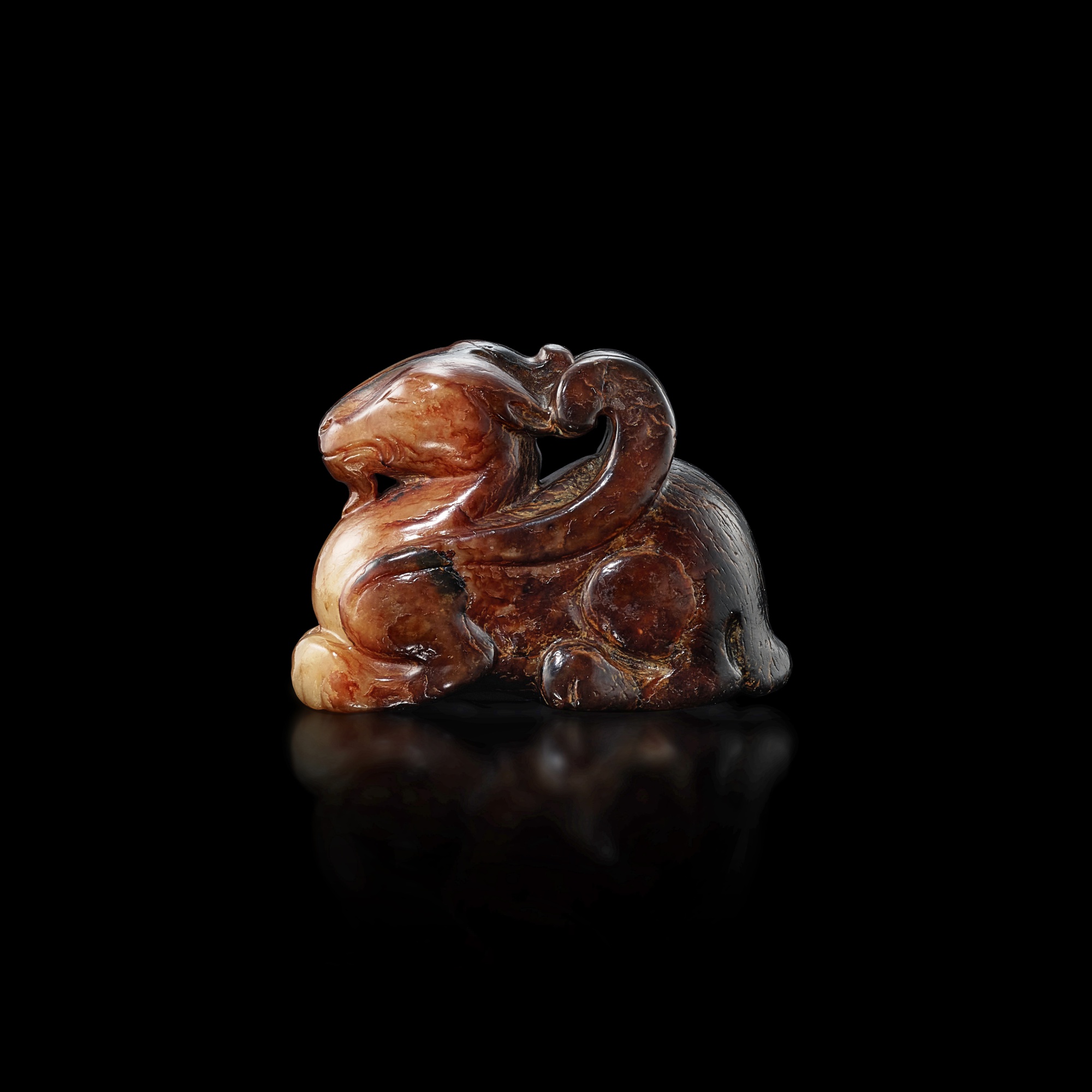 A white and brown jade mythical animal, Ming dynasty or earlier 明或更早 ...
