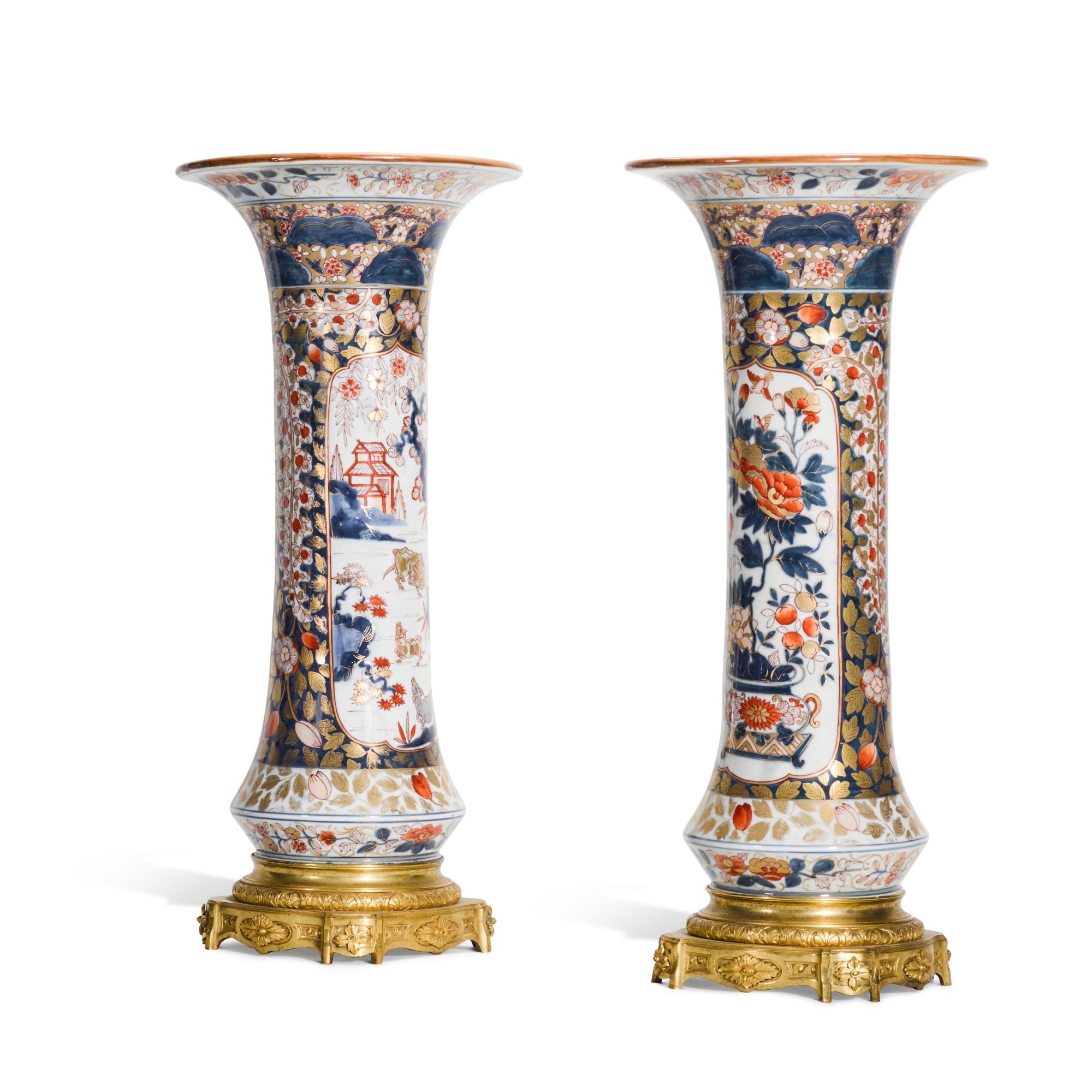 A pair of French gilt-bronze mounted trumpet vases, the porcelain by ...