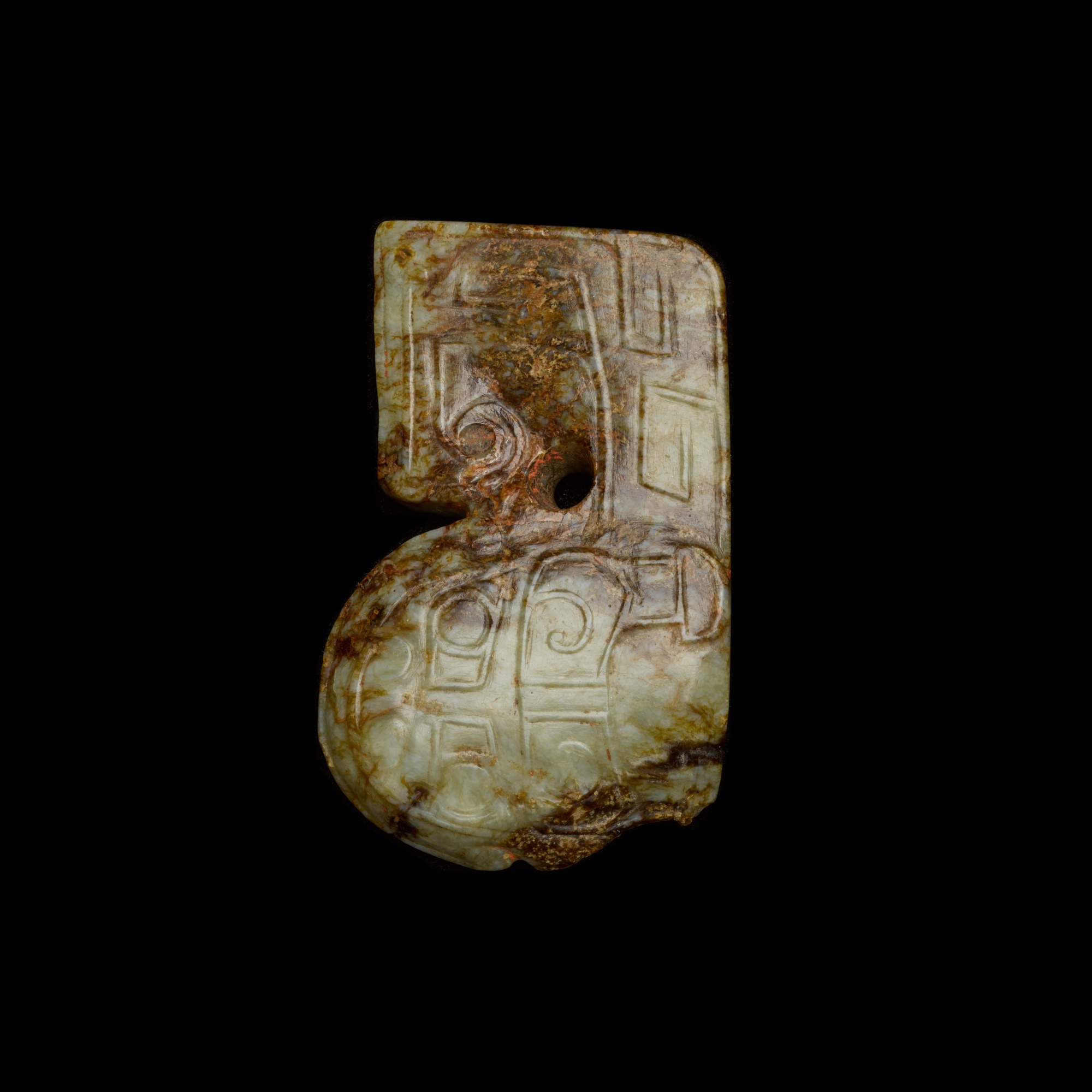 A small grey and brown 'bottle-horn dragon' jade pendant, Shang dynasty ...
