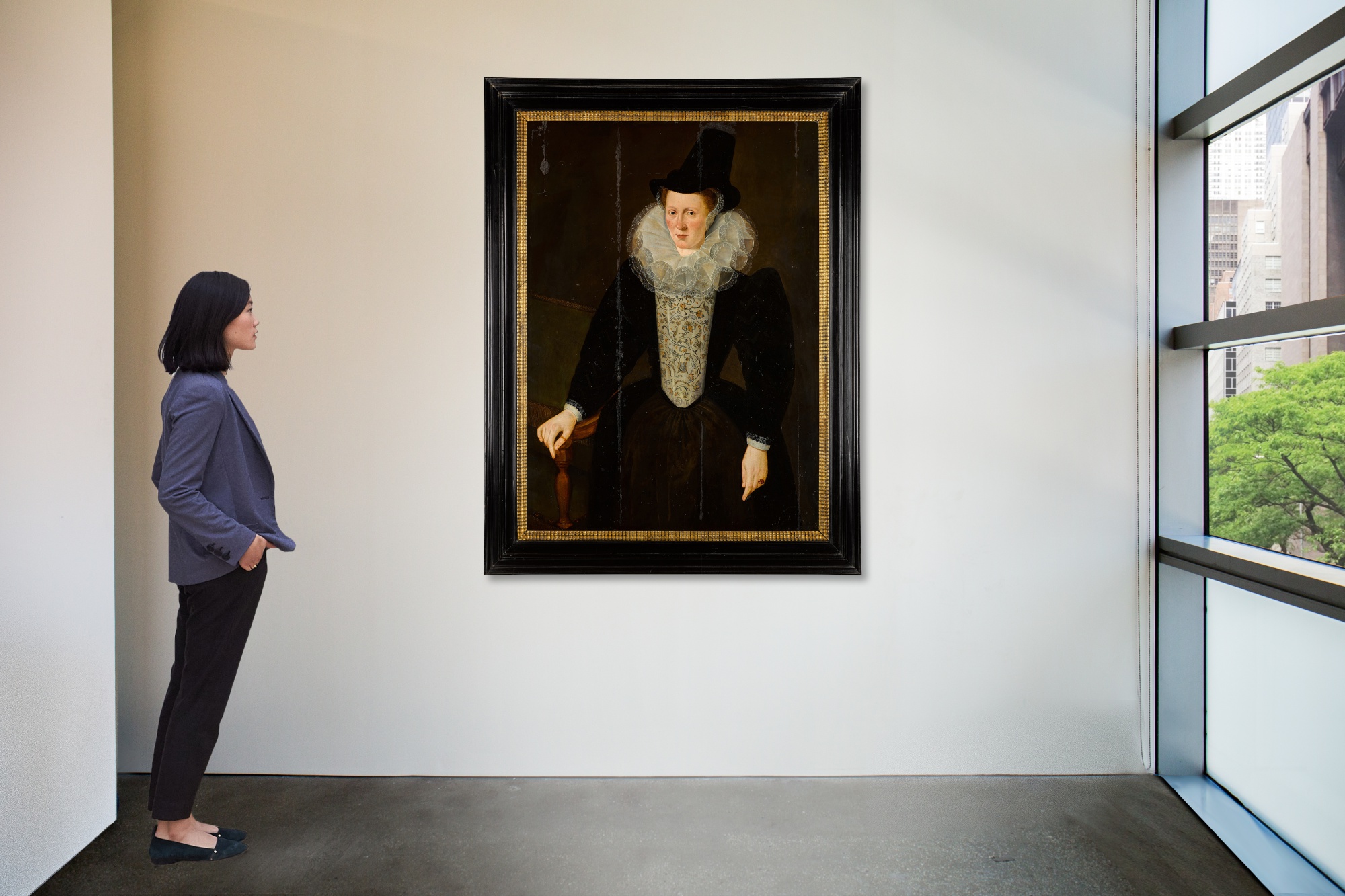 Portrait of a lady, three-quarter-length, wearing a black dress with an ...