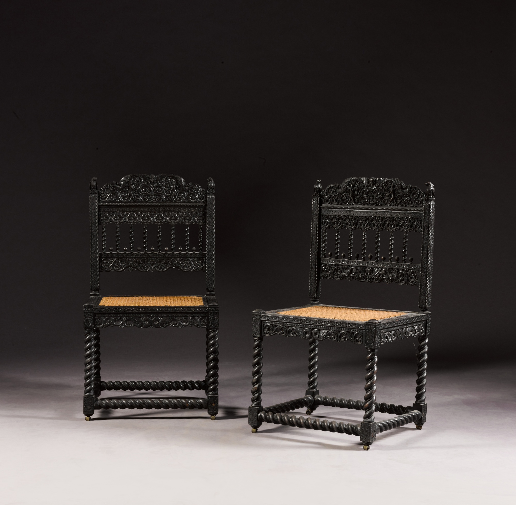 A near matched pair of Indo-Dutch ebony side chairs, India, Coromandel ...