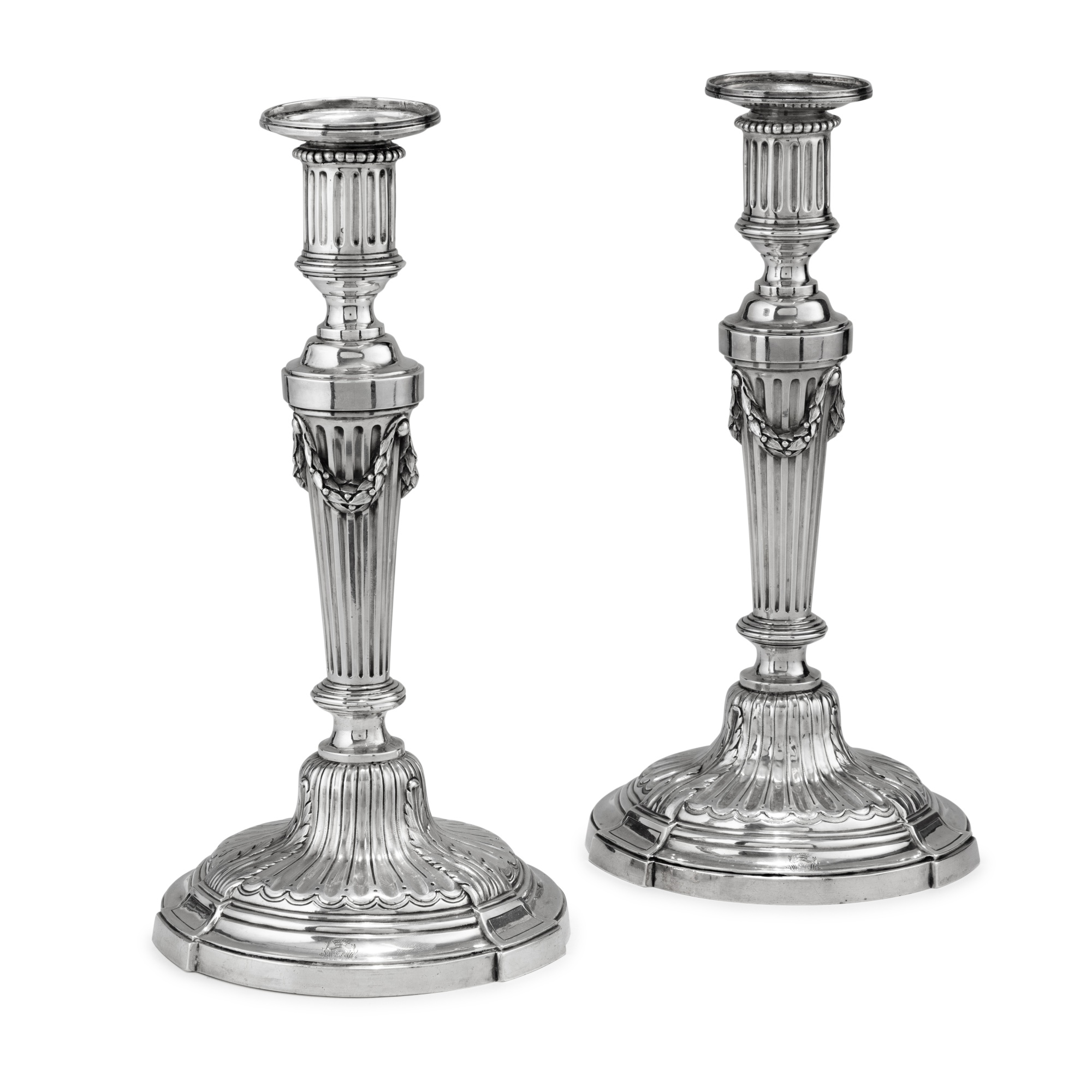 A pair of silver candlesticks and nozzles, Charles Louis Auguste ...