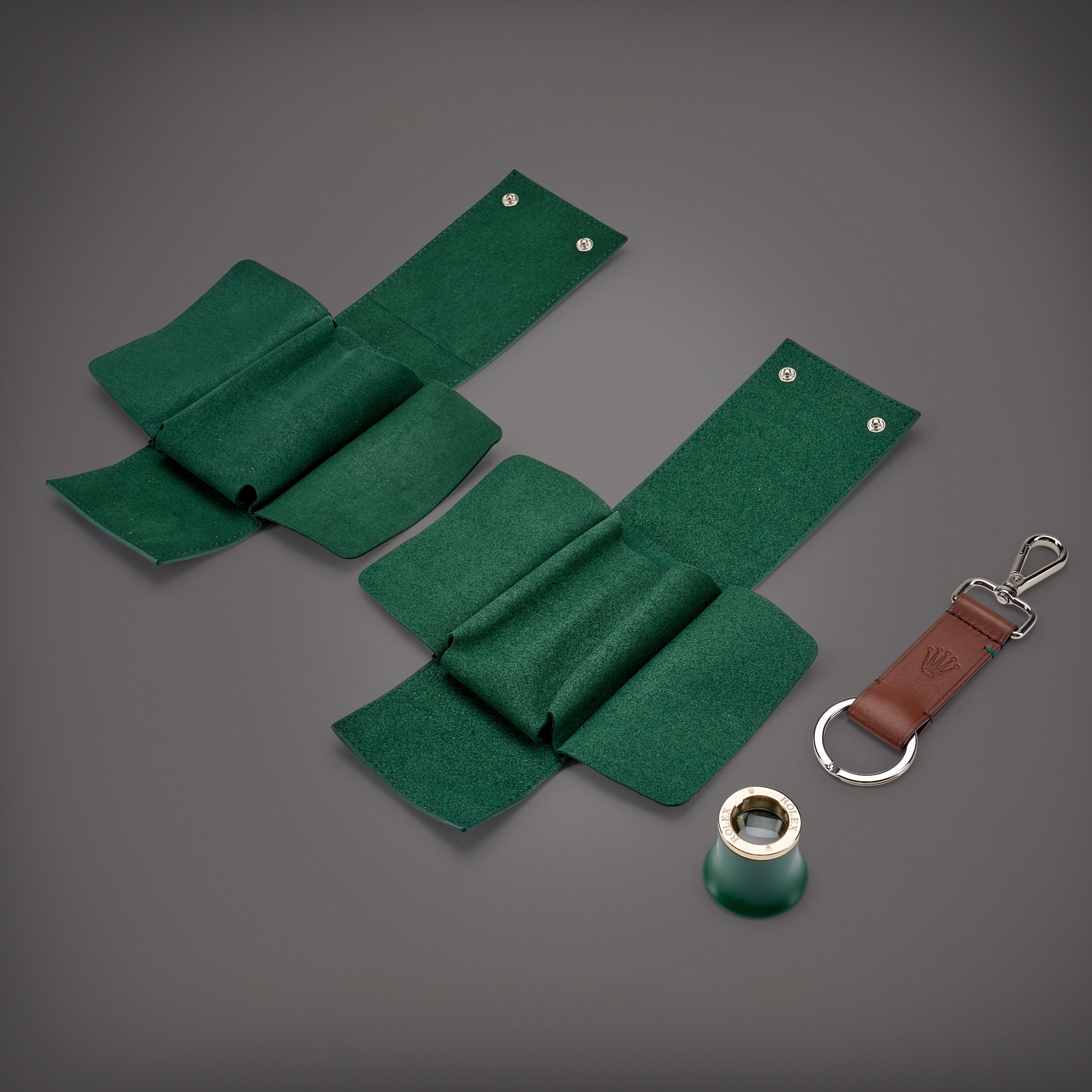 A set of magnifying loupe, keychain and two travelling pouches, Circa ...