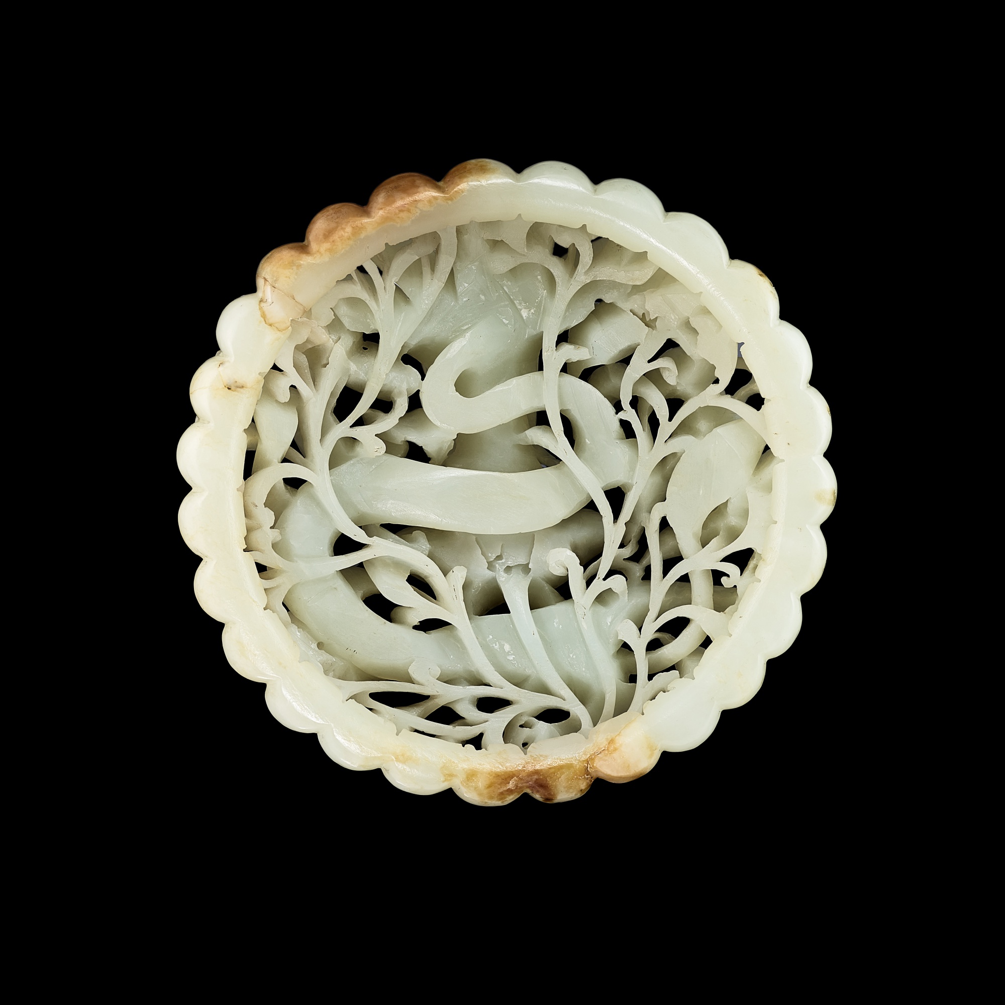 A reticulated white and russet jade 'dragon' plaque, Ming dynasty 明 ...
