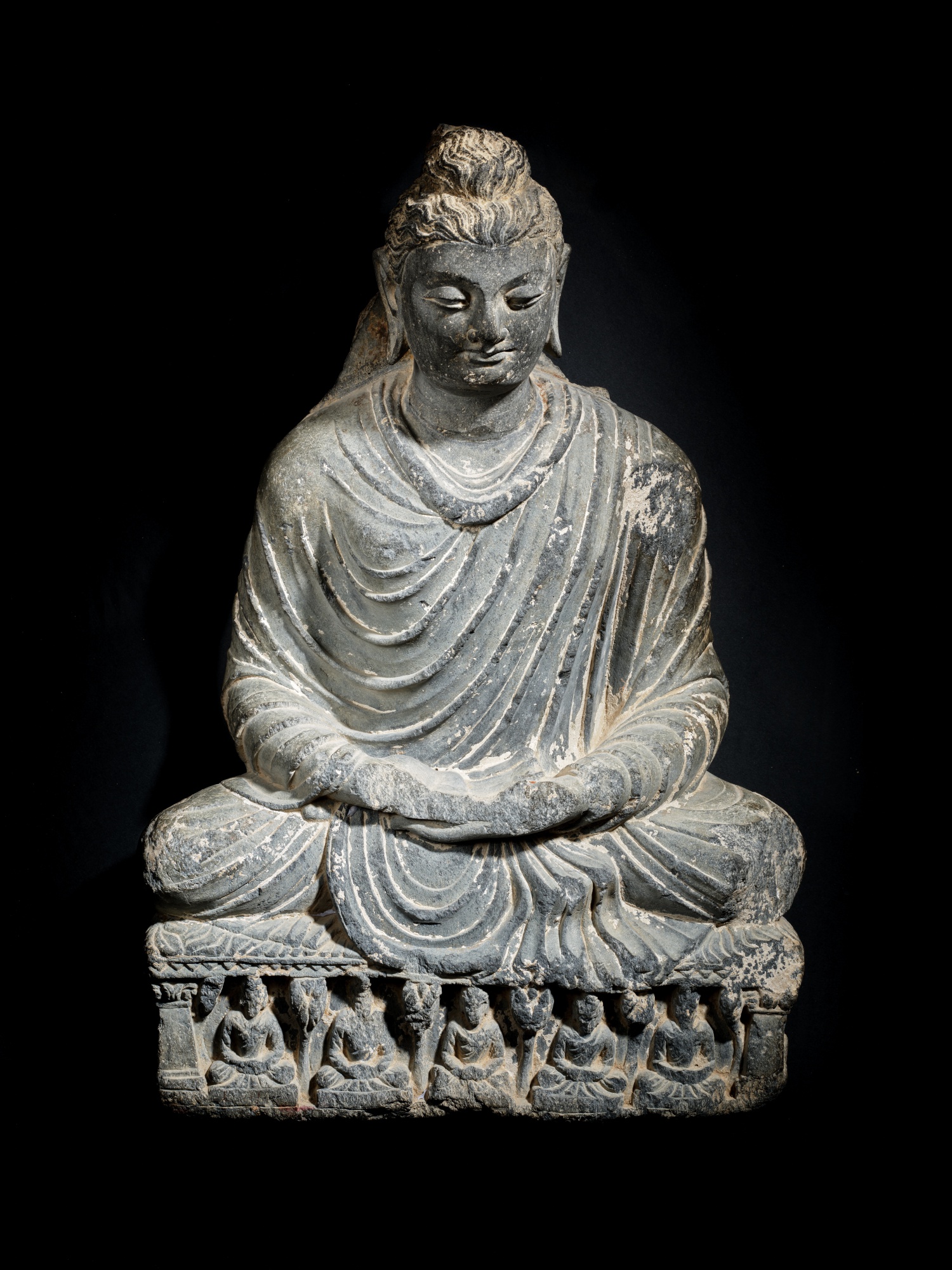 A gray schist figure of seated Buddha, Ancient Region of Gandhara, 2nd ...