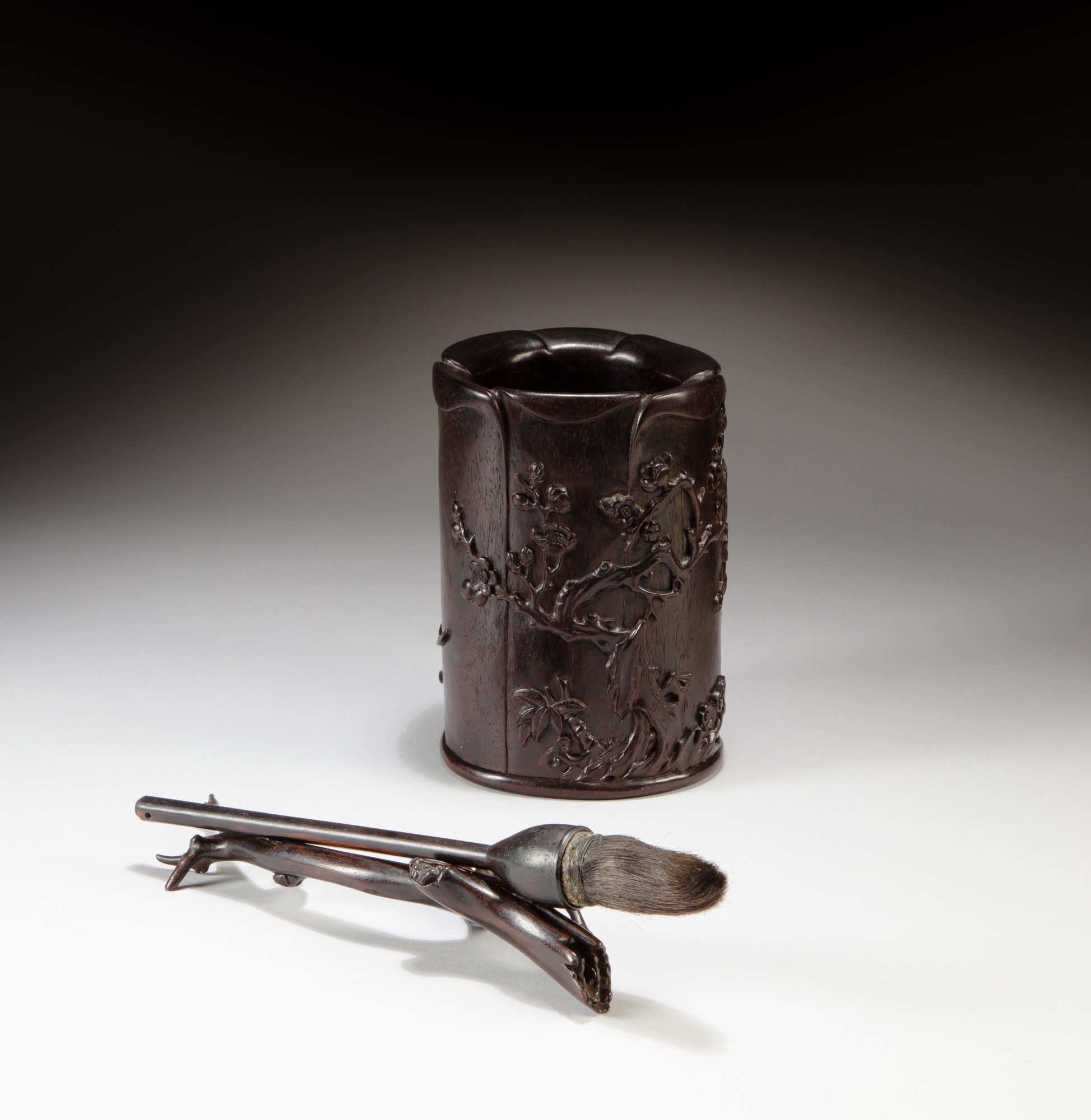 A 'zitan' magnolia-shaped 'prunus and lotus' brushpot, Qing dynasty, 18th century, and a brush ...
