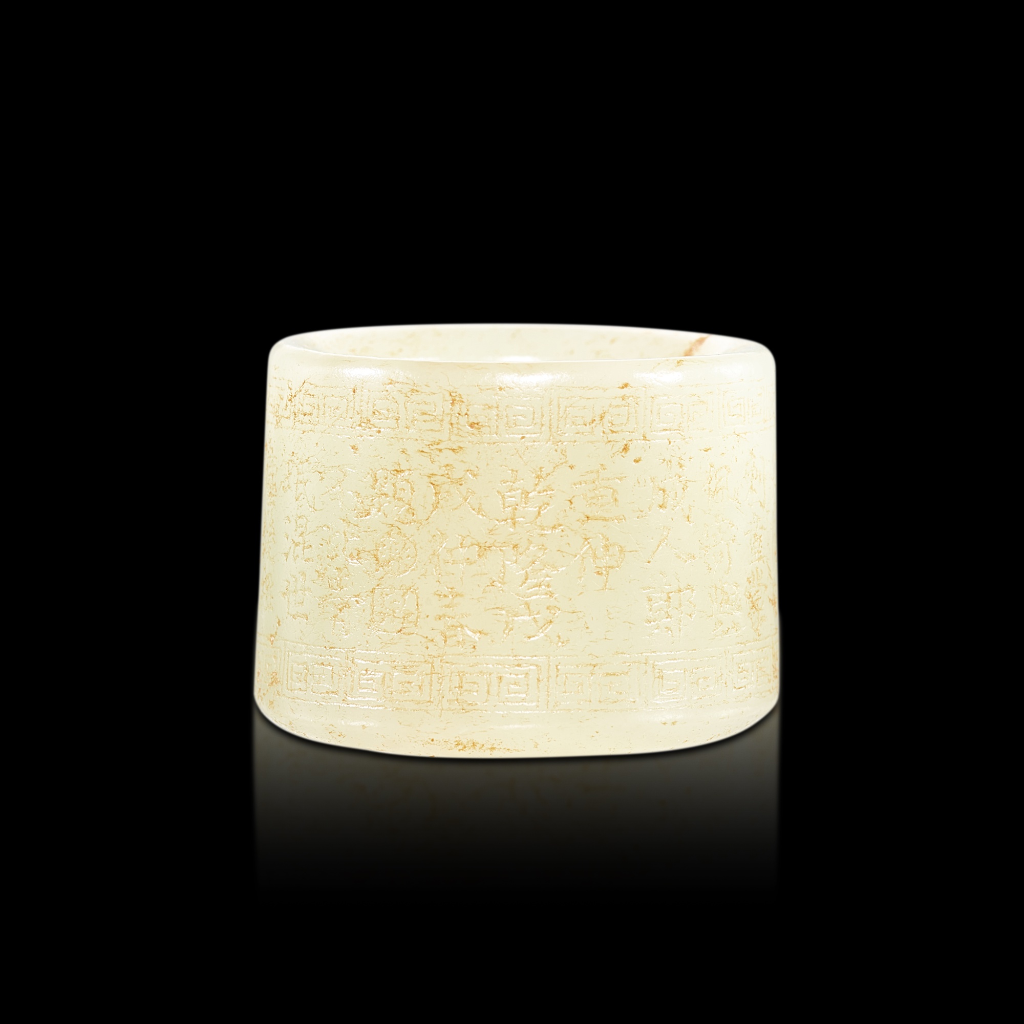An inscribed white and russet jade archer's ring, Qing dynasty ...