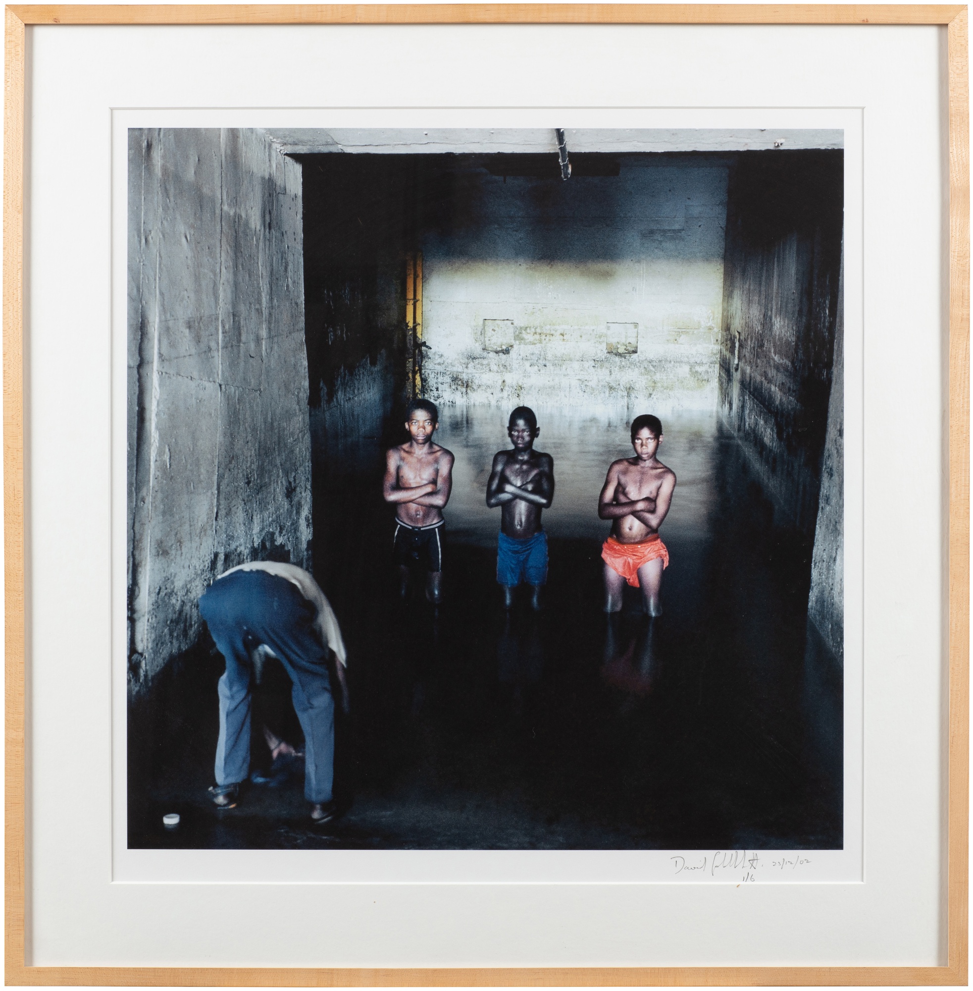 Fernando Augusto Luta washes his clothes while Augusto Mokinda (13), Ze ...