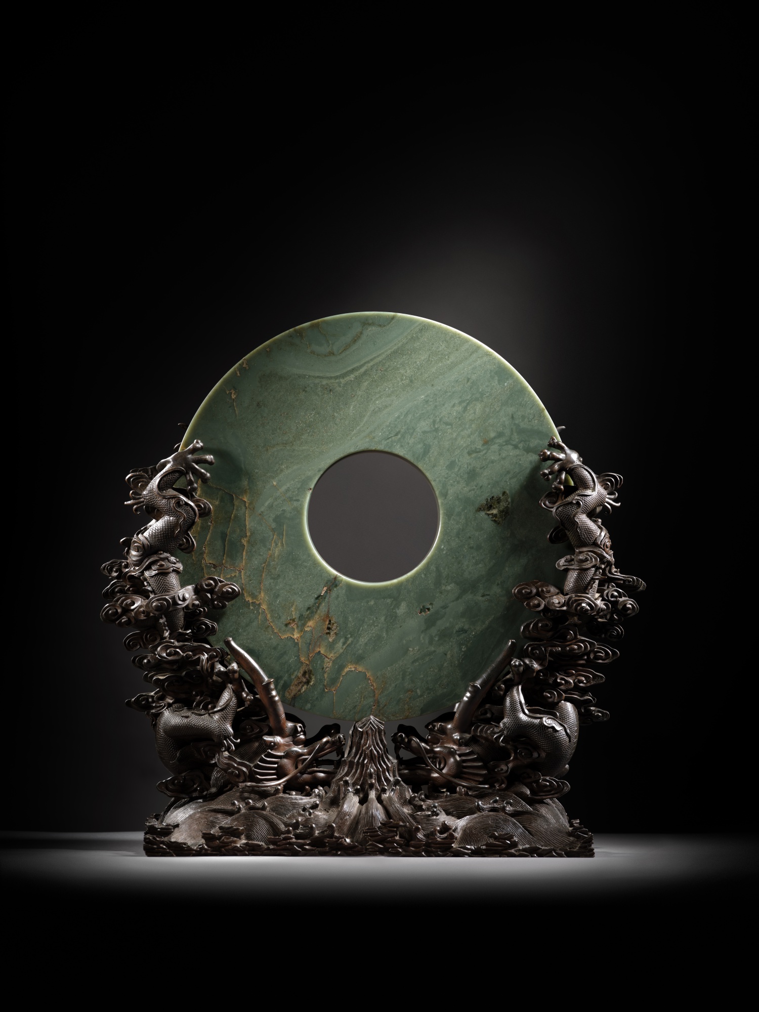 An imperial massive Khotan-green jade bi disc with original bronze ...