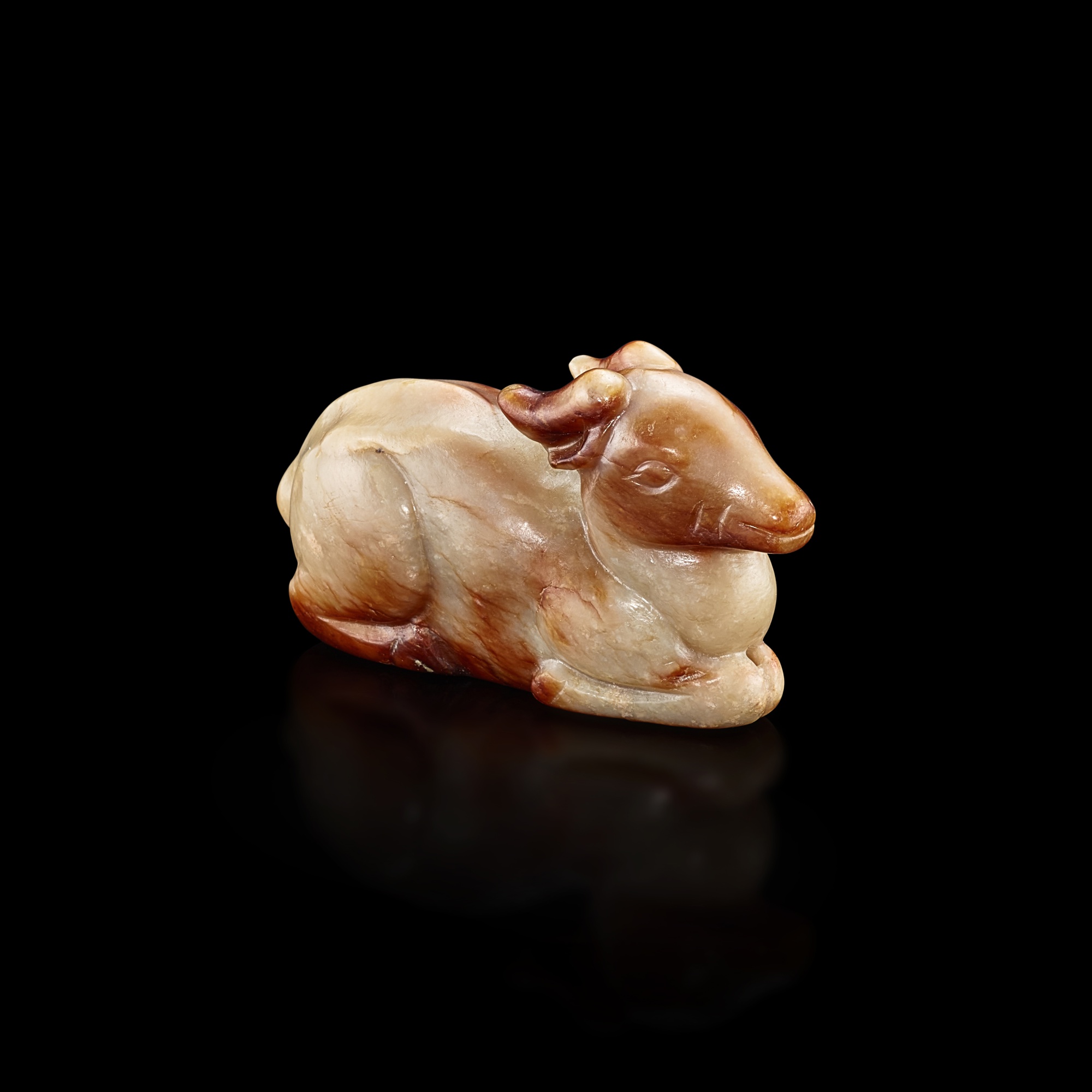 A white and russet jade recumbent deer, Ming dynasty or earlier 明或更早 ...