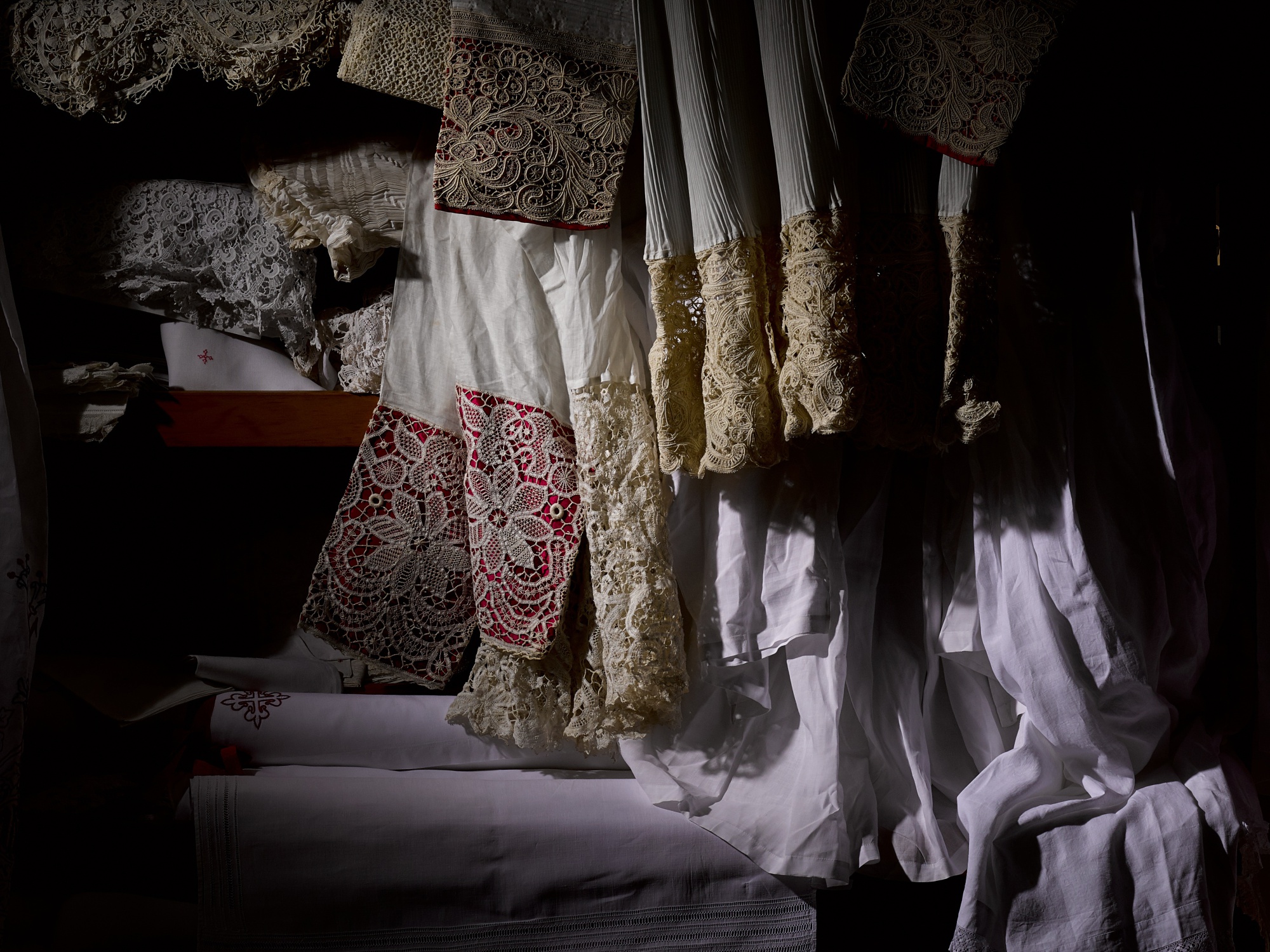 A group of linen and lace vestments and linen church service ...