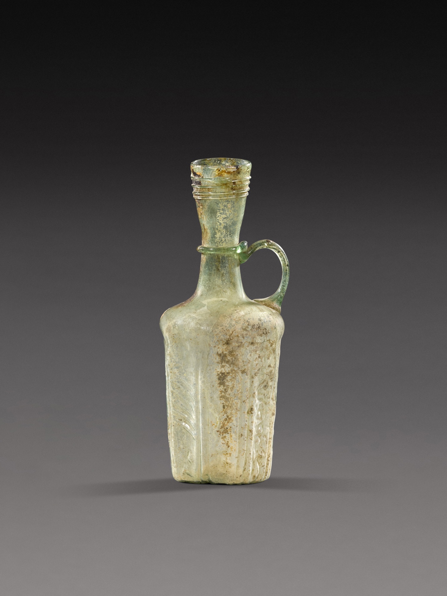 A Roman Pale Green Mould-Blown Glass Jug, circa 1st century A.D ...