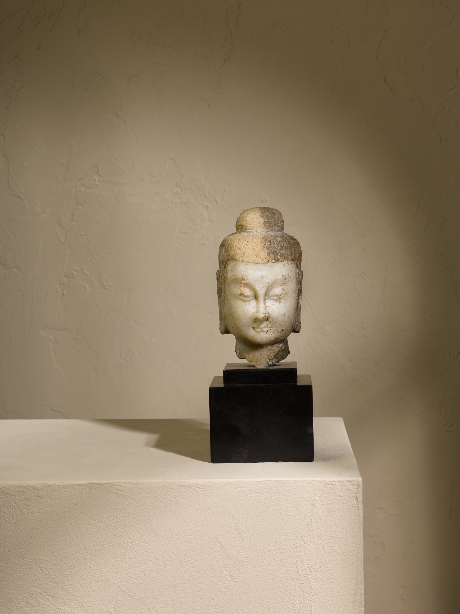 A small white marble head of a Buddha, Northern Wei dynasty or later ...