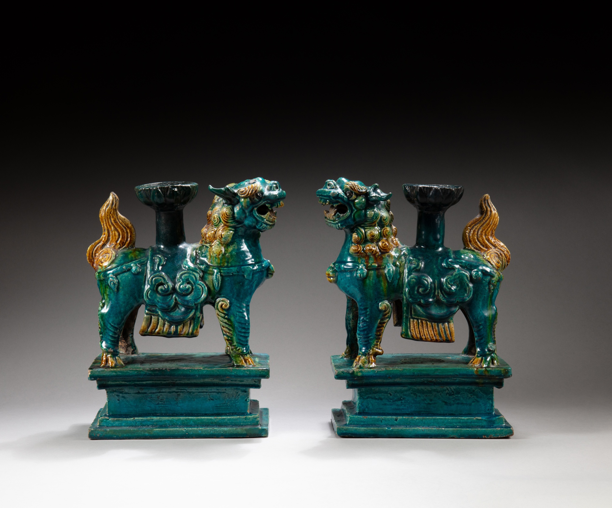 A pair of turquoise-and-yellow-glazed 'qilin' candlesticks, 17th-18th ...
