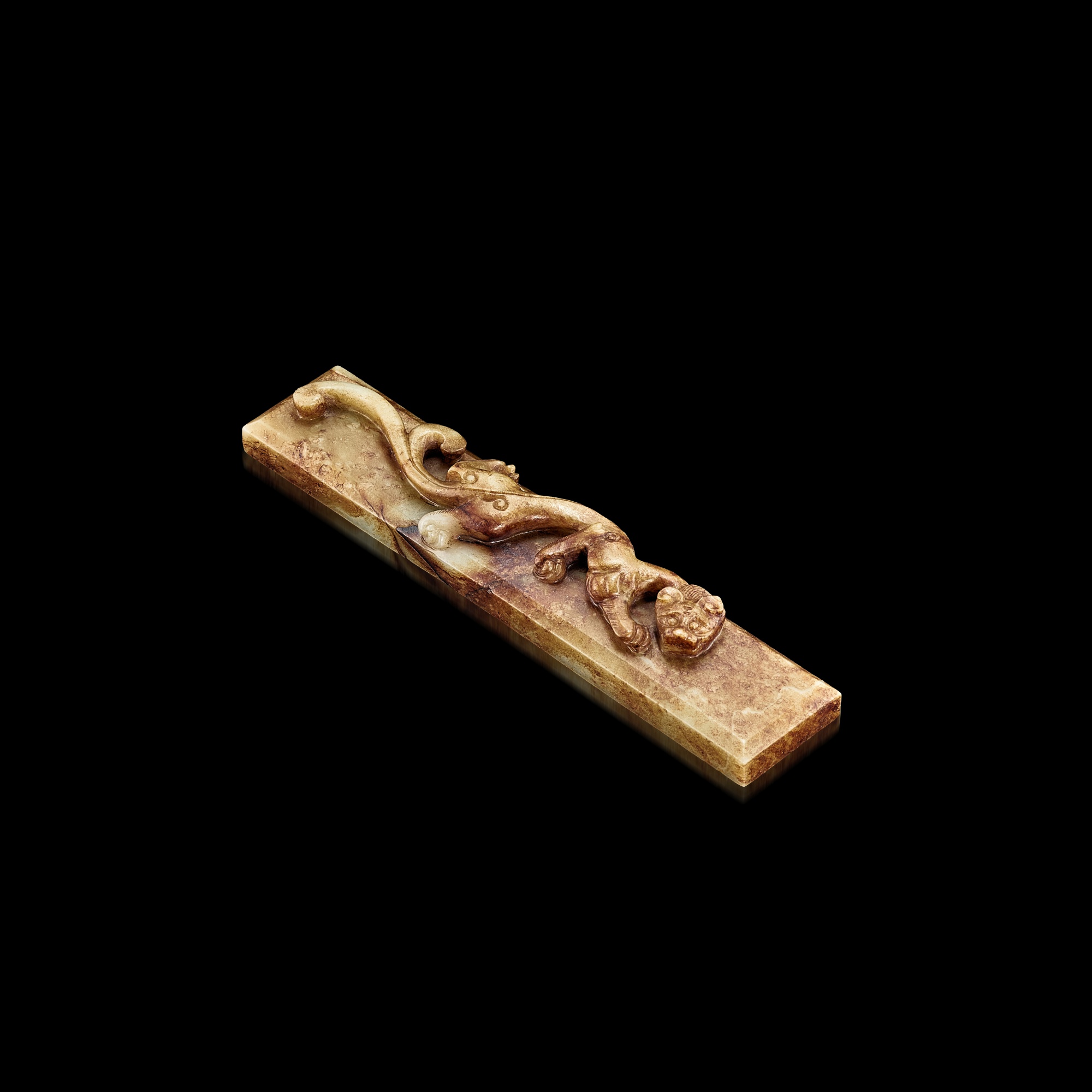 A celadon and russet jade 'chilong' scroll weight, Ming dynasty 明 ...