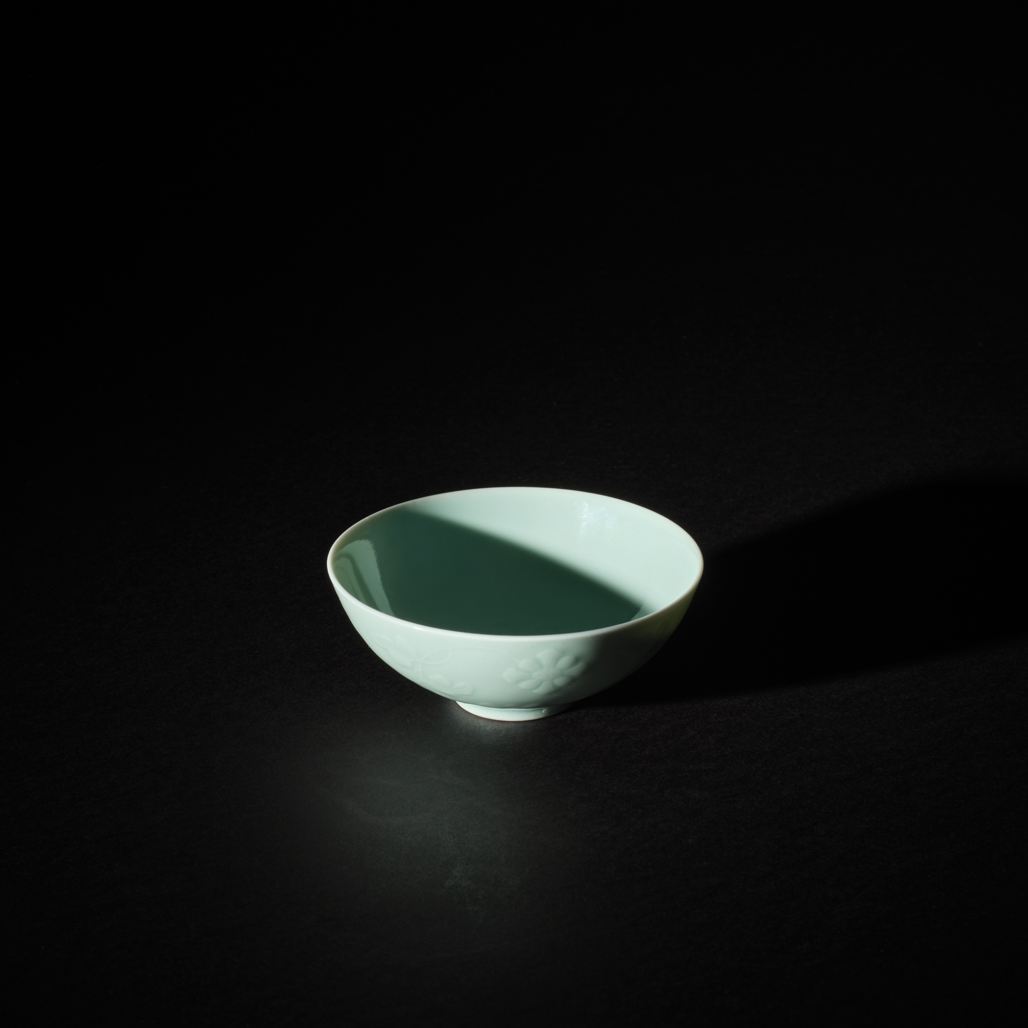 A fine molded celadon-glazed 'floral' bowl, Mark and period of ...