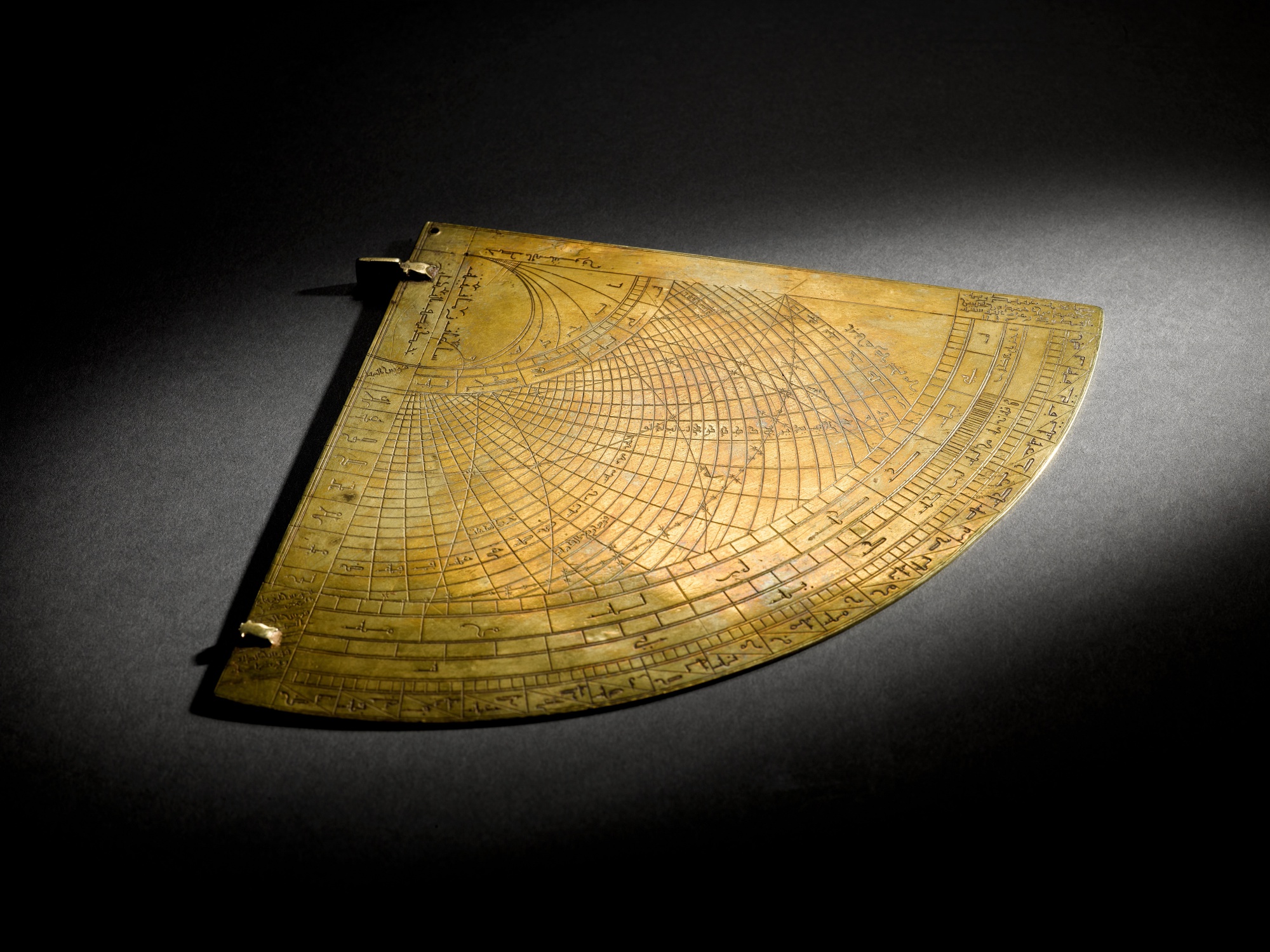 A rare brass astrolabic quadrant, signed by Muhammad ibn Ahmad ibn ...