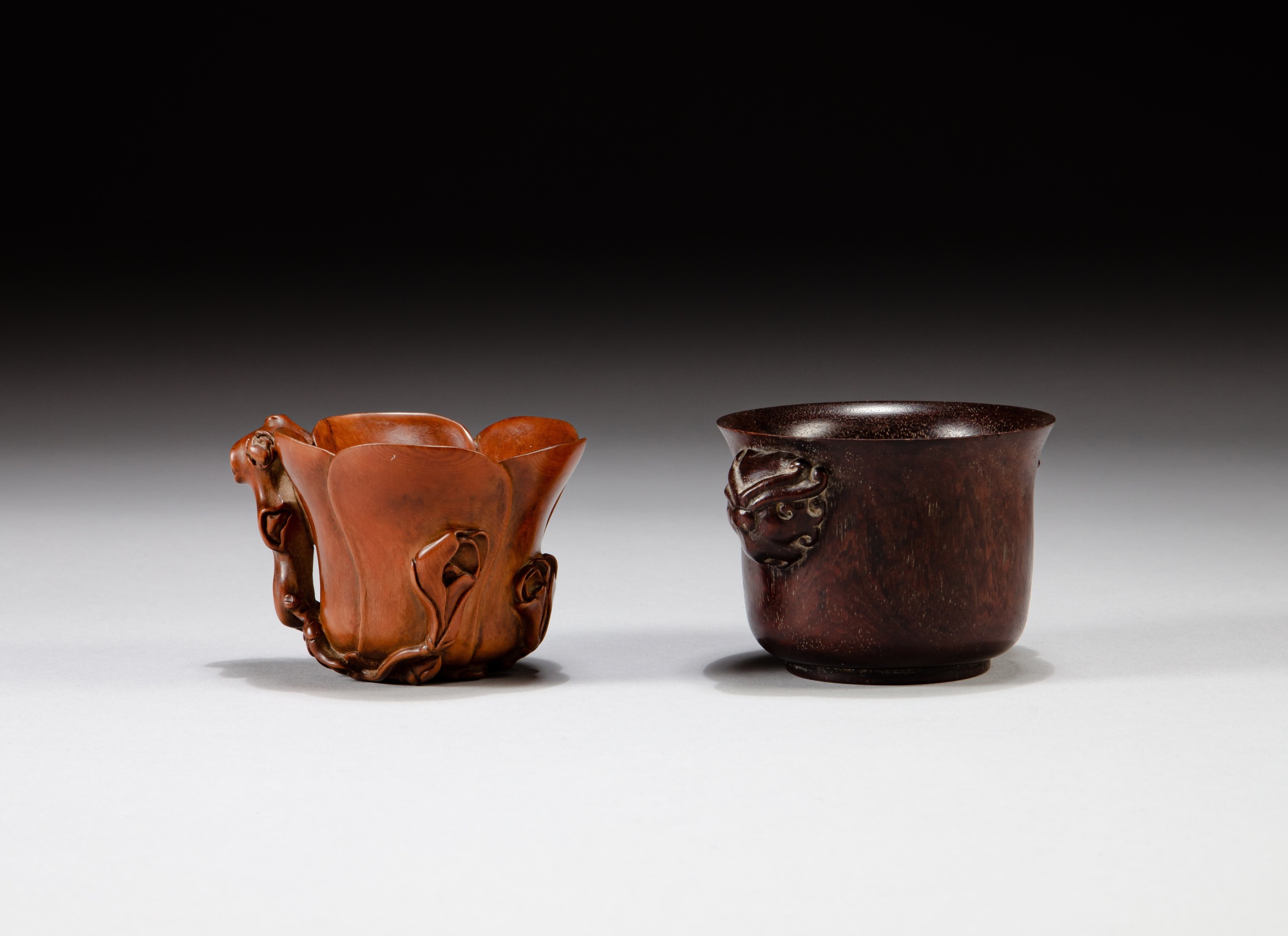 An archaistic handled 'zitan' cup and a boxwood magnolia-shaped cup ...