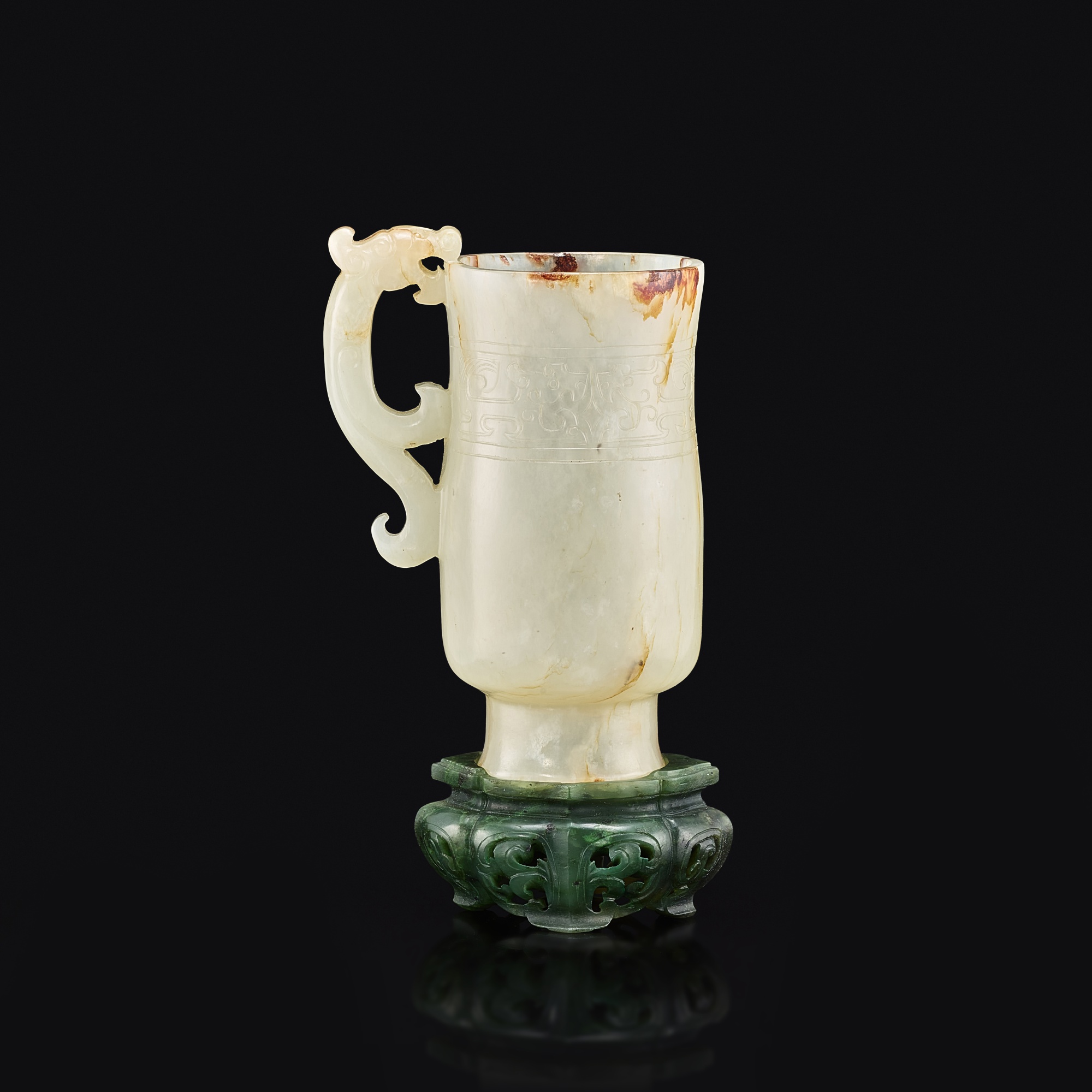 An archaistic white jade 'chilong' cup and a spinach-green jade stand ...