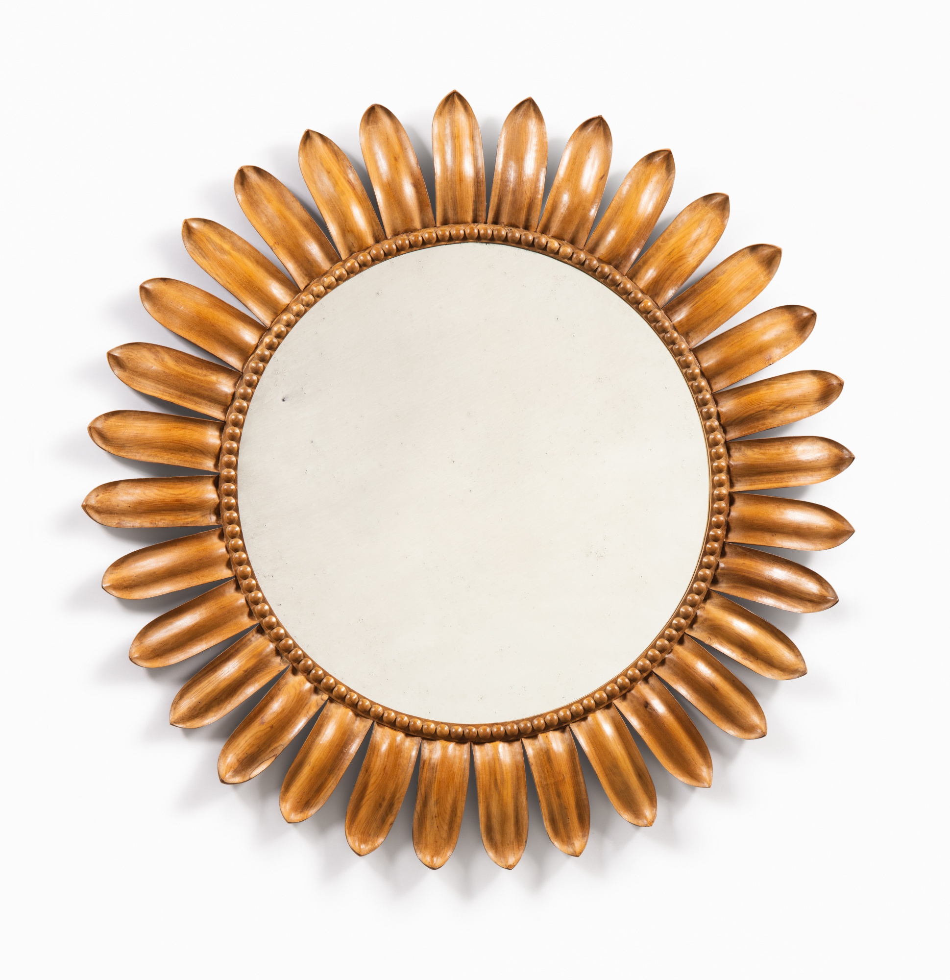A large carved wood lotus petal mirror, designed by Andrew Allfree (b ...