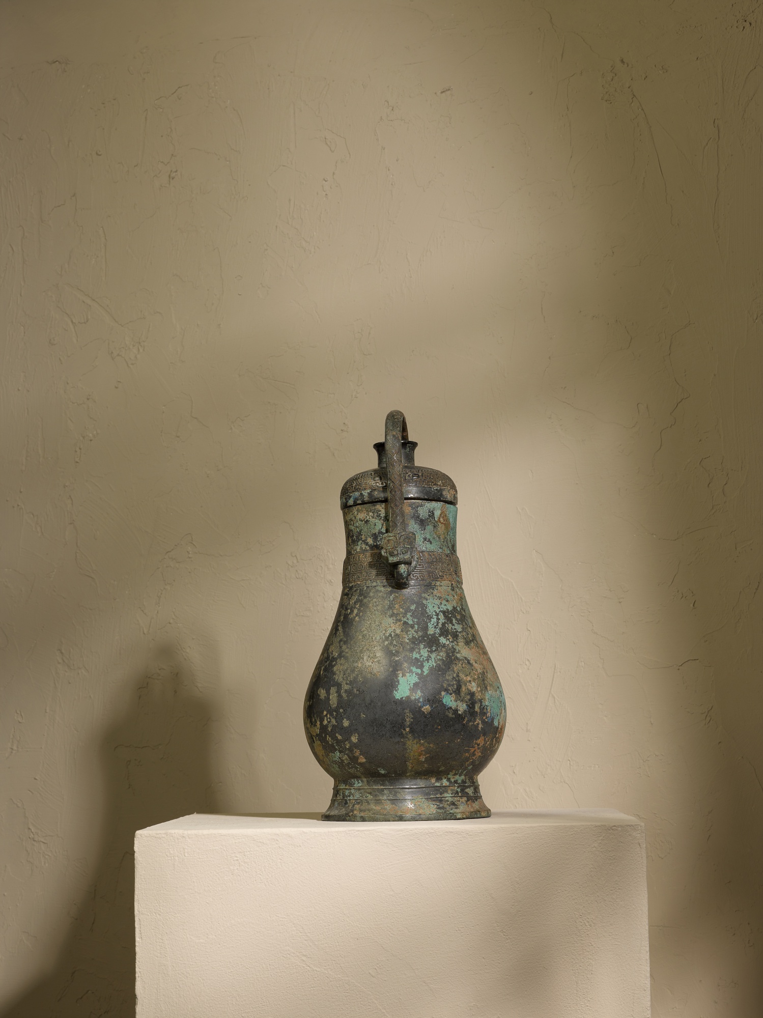 A rare large inscribed archaic bronze ritual wine vessel and cover, Hu ...