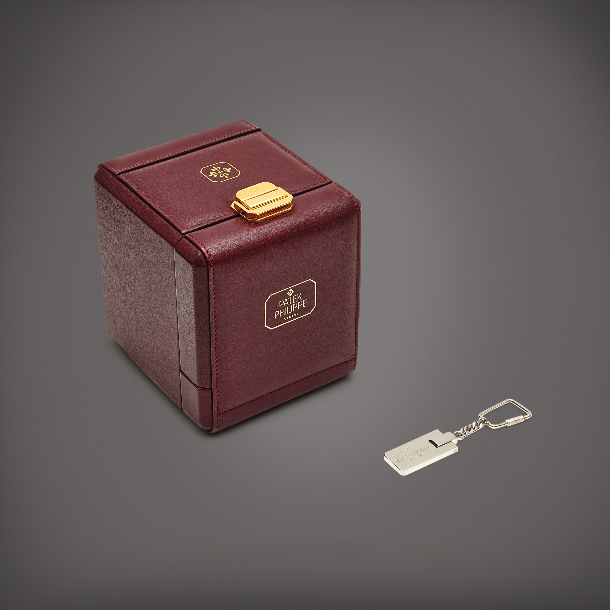 A set of leather winding box and keychain, Circa 1990 | 百達翡麗 | 一套皮製自動上弦 ...