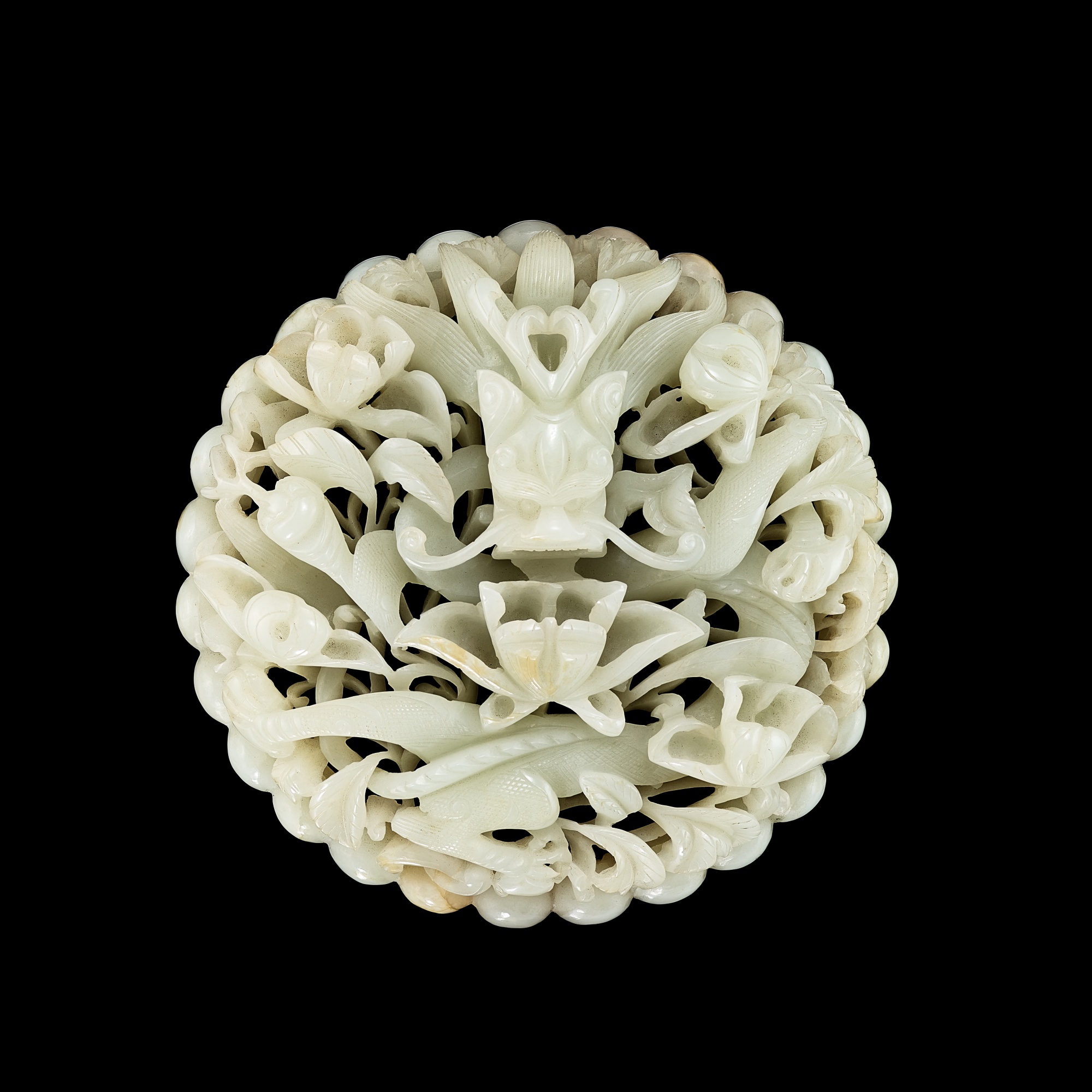 A reticulated white and russet jade 'dragon' plaque, Ming dynasty 明 ...
