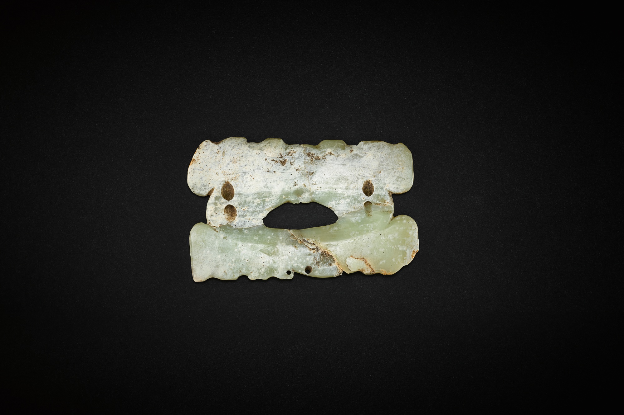 A rare yellowish-celadon jade 'animal mask' ornament, Neolithic period ...